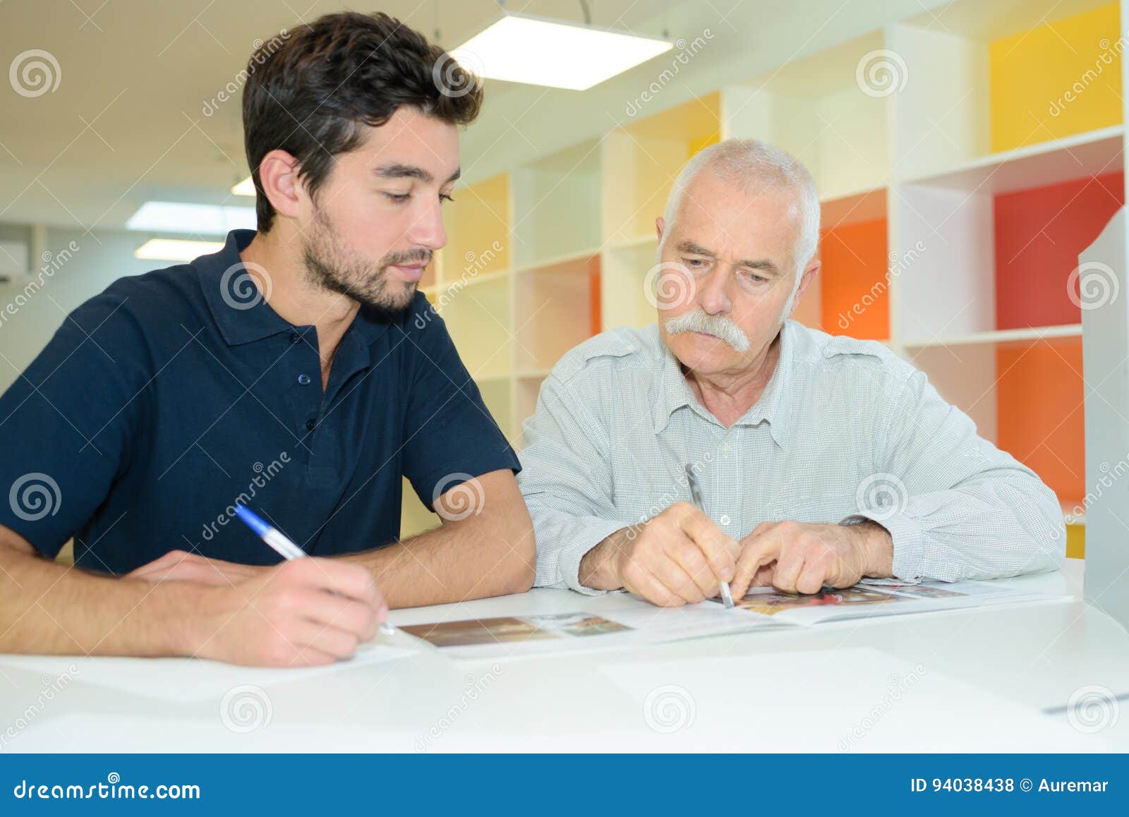 Two Colleagues Writing Something on Paper Stock Photo - Image of ...