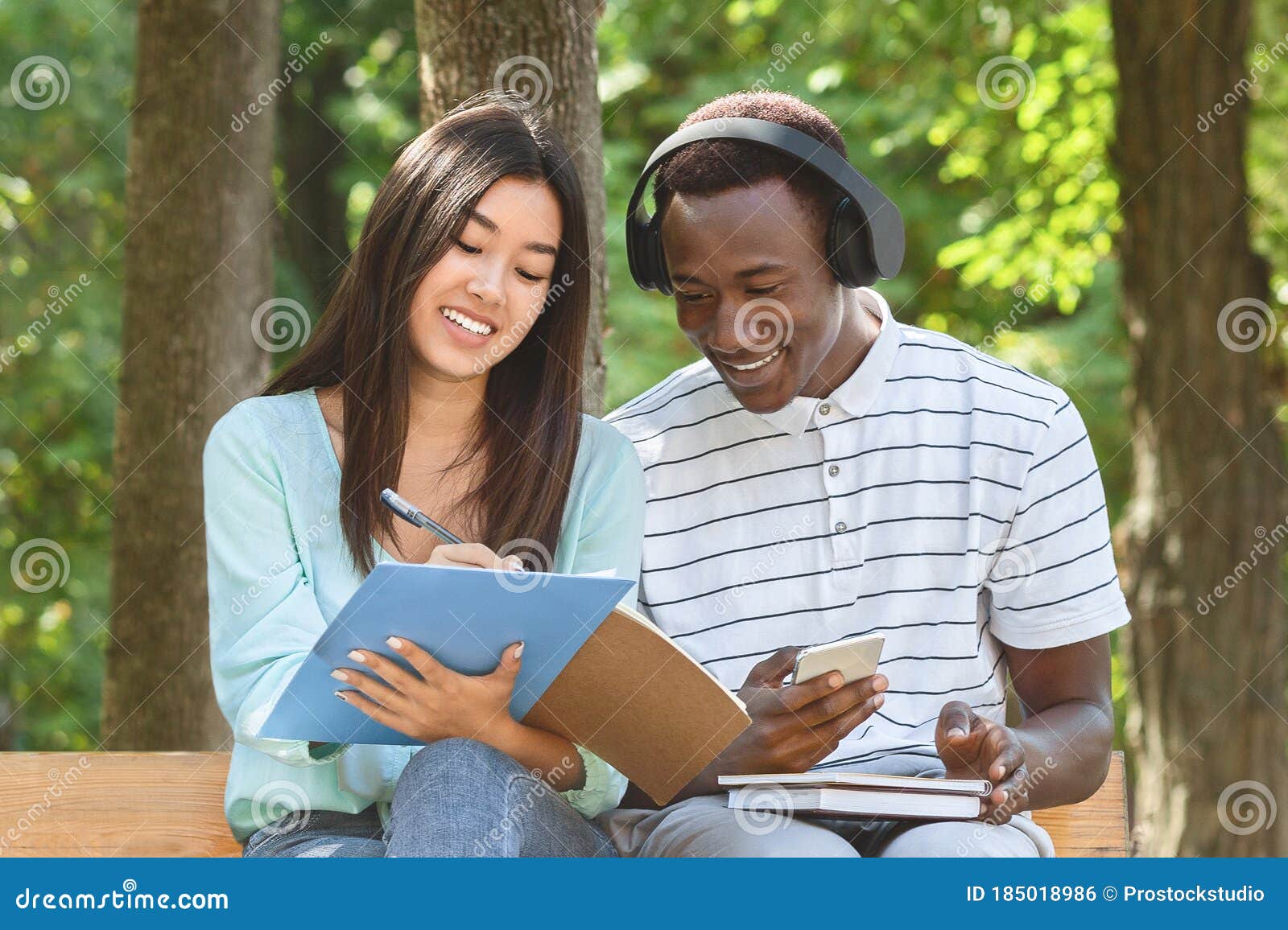Two College Mates Preparing for Lectures, Studying Together Outdoors ...
