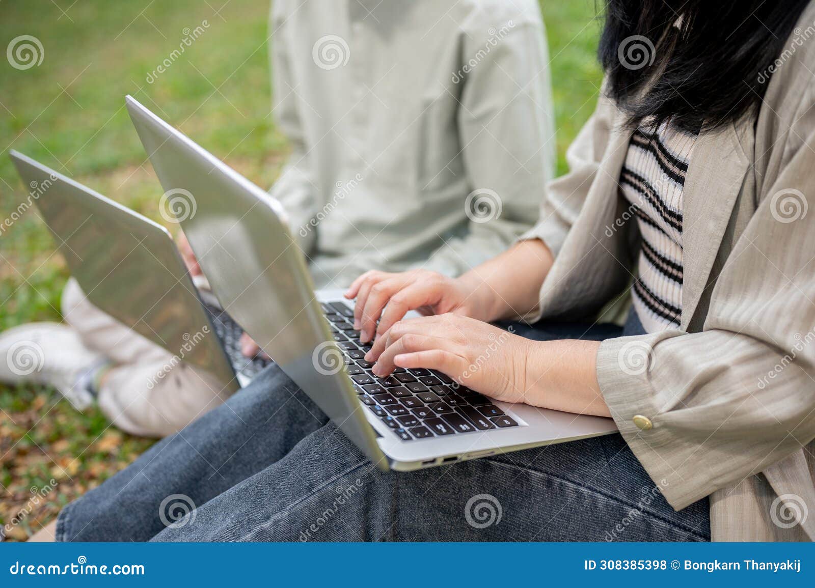Two College Students Collaborating on Work and Using Their Laptop ...