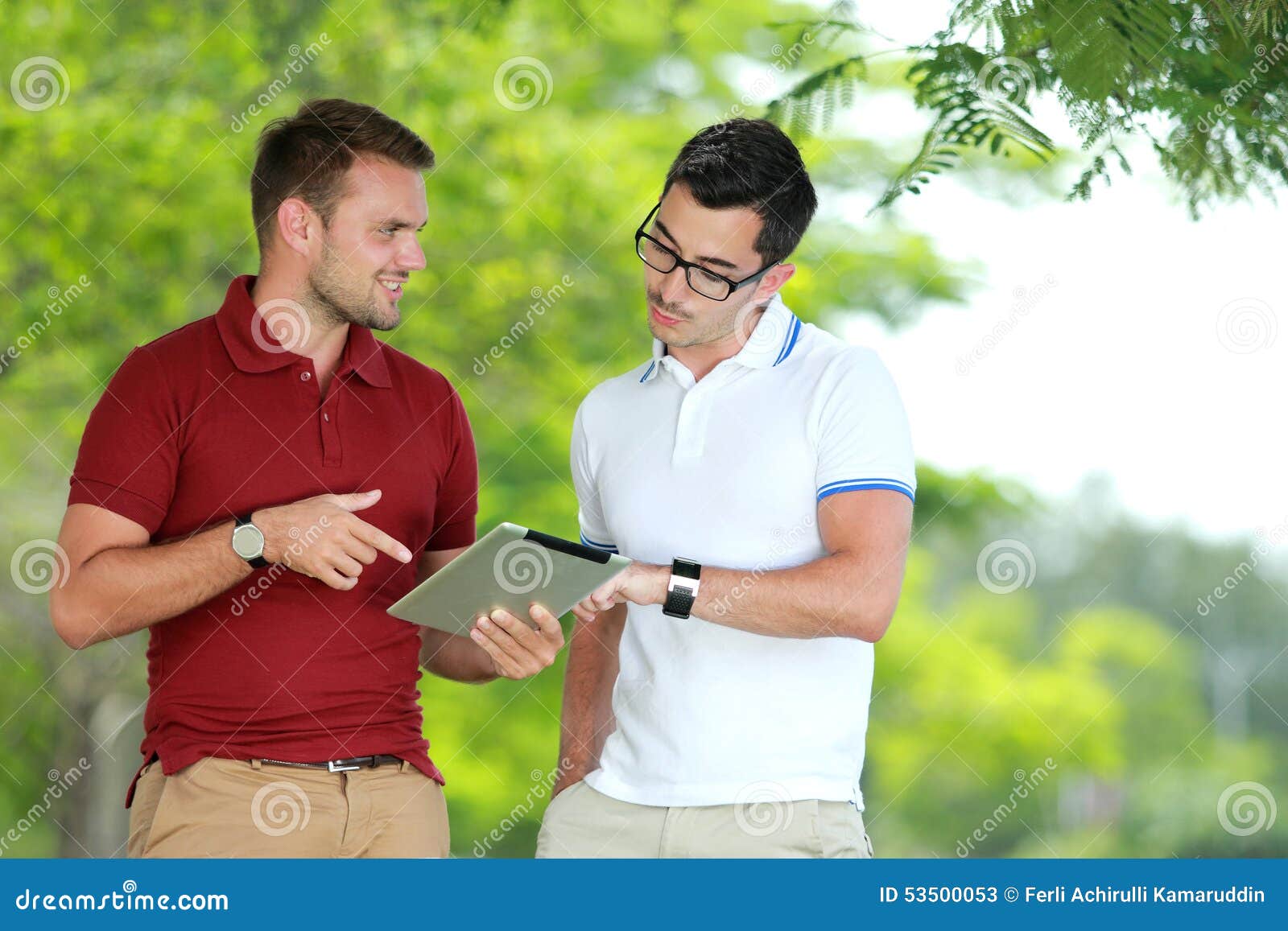 Two College Students Discussing an Assignment Using Tablet Stock Image ... Two College Students Discussing an Assignment Using Tablet Stock Image ...