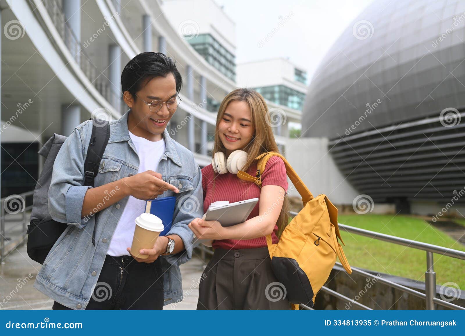 Two College Students Sharing Ideas or Discussing Something while ...