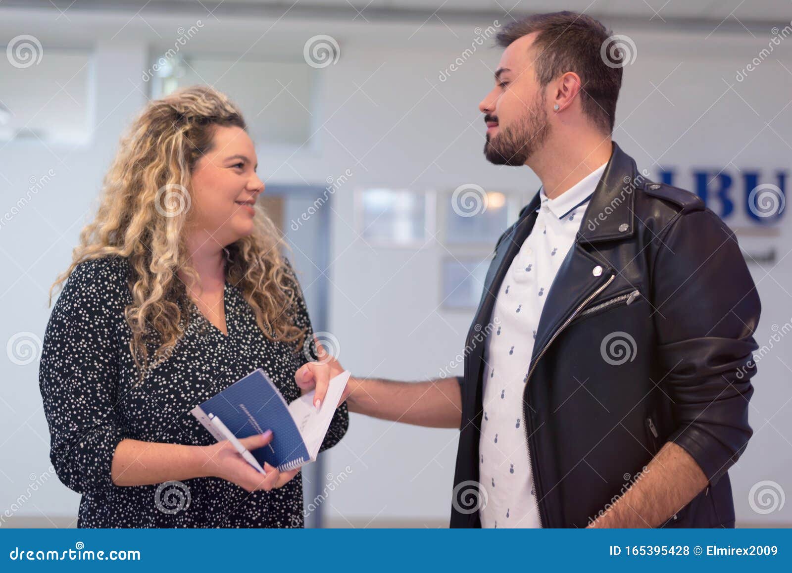 Two College Students Standing in Corridor and Chatting after Their ...