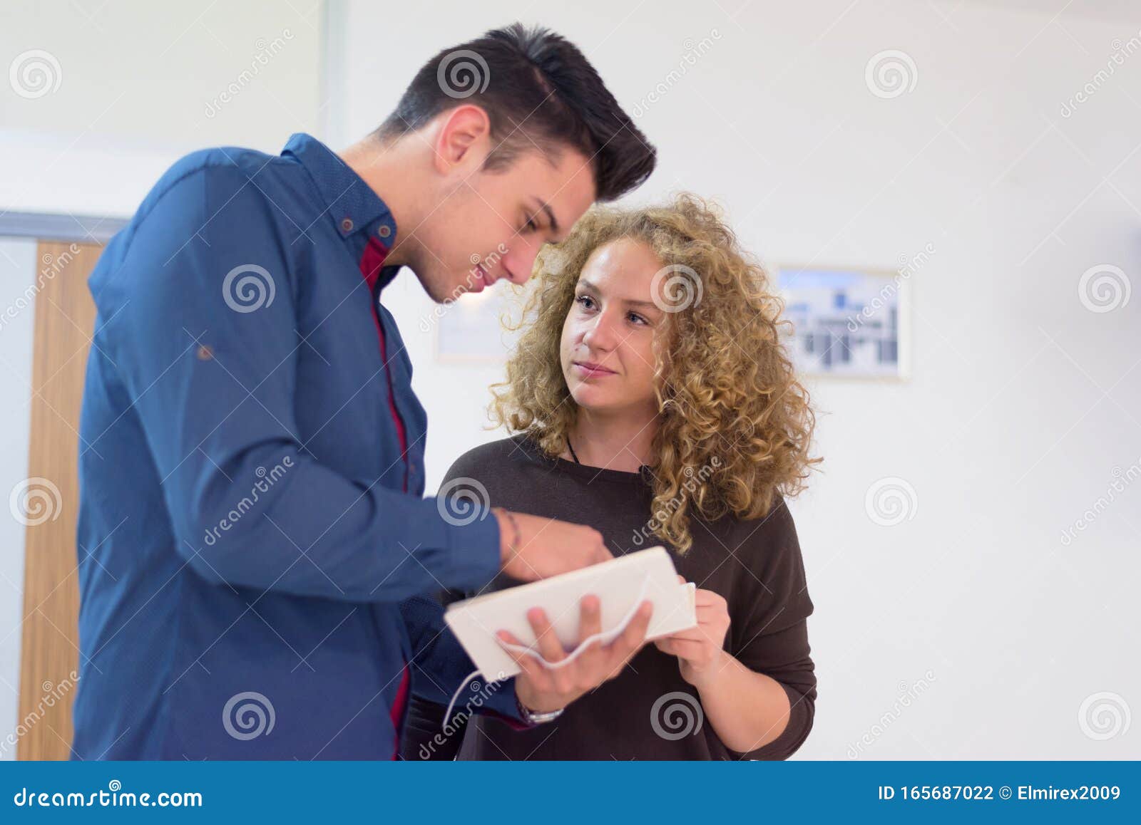 Two College Students Standing in Corridor and Chatting after Their ...