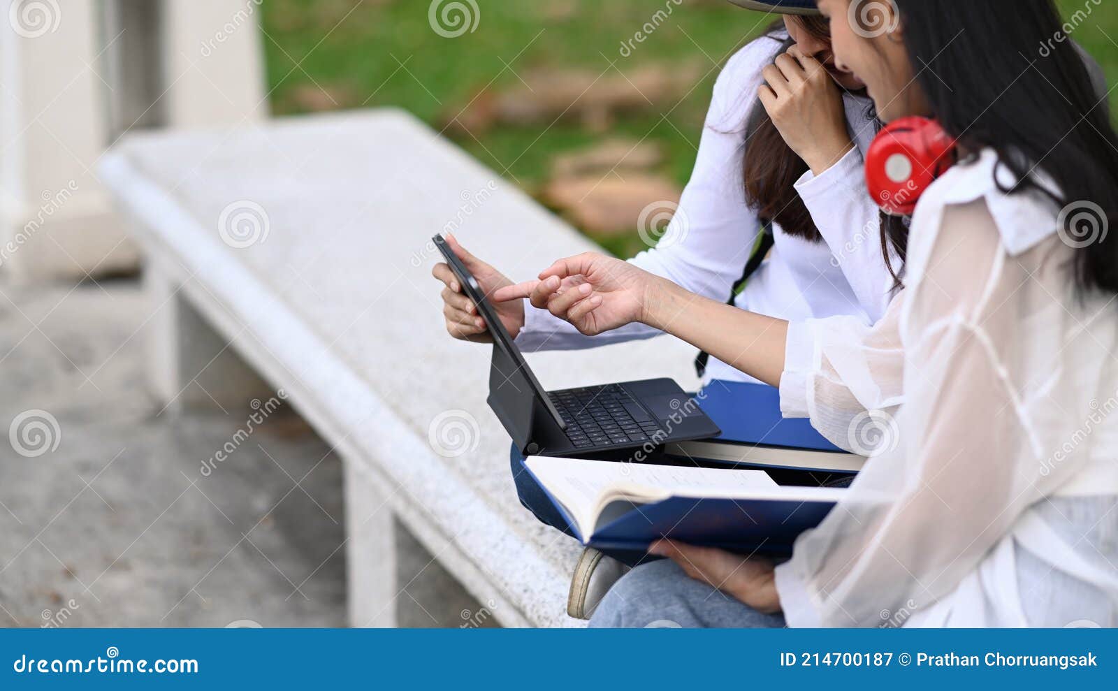 Two College Students Using Computer Tablet and Talking Each Other in ...