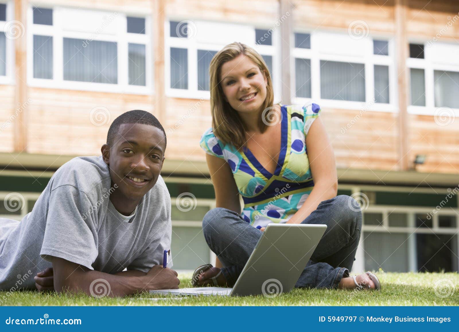 Two College Students Using Laptop on Campus Lawn, Stock Image - Image ...