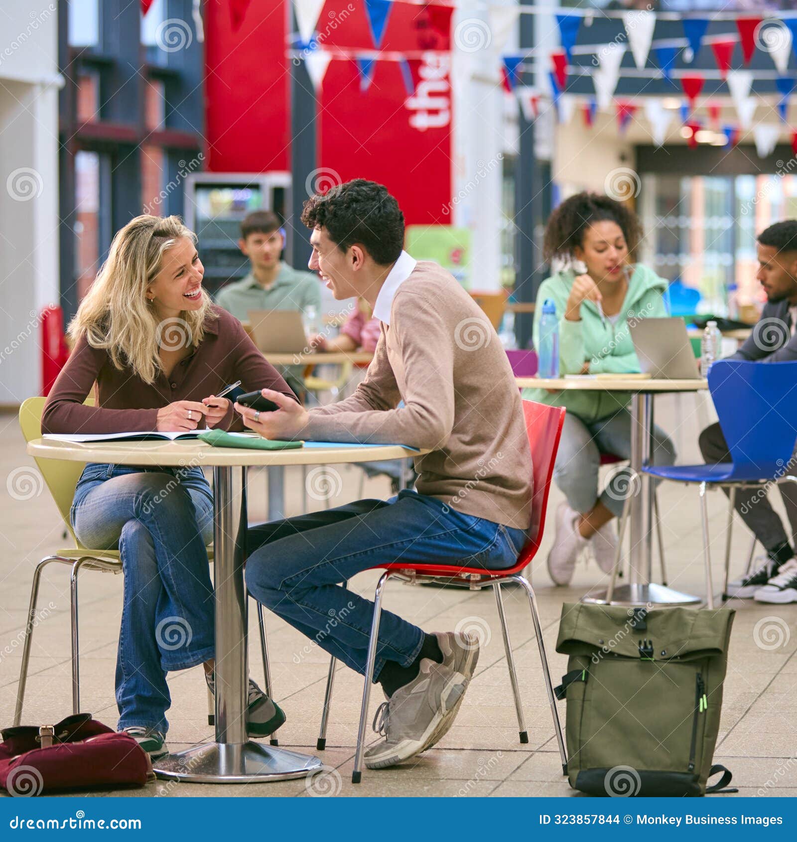 Two College or University Students with Mobile Phone Working Together ...