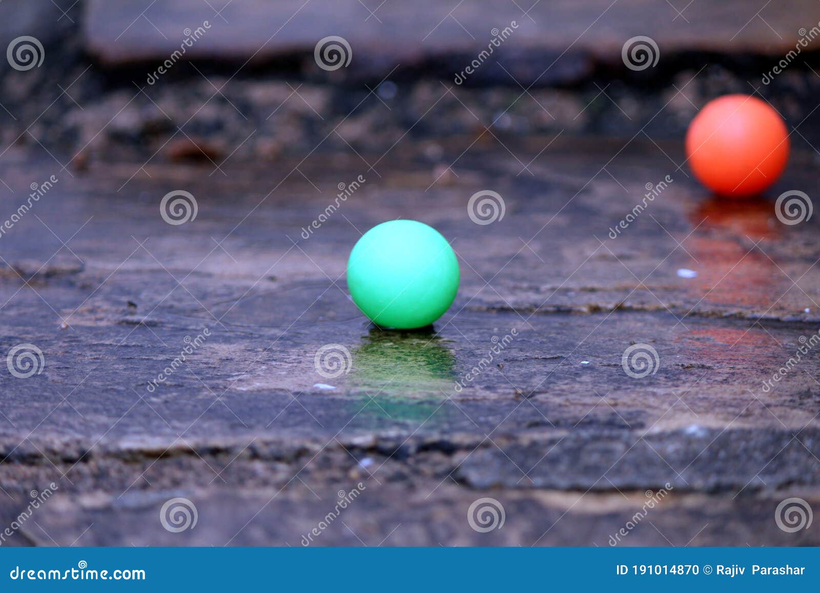 Two Color Ball on Wet Stone Stock Photo - Image of party, game: 191014870