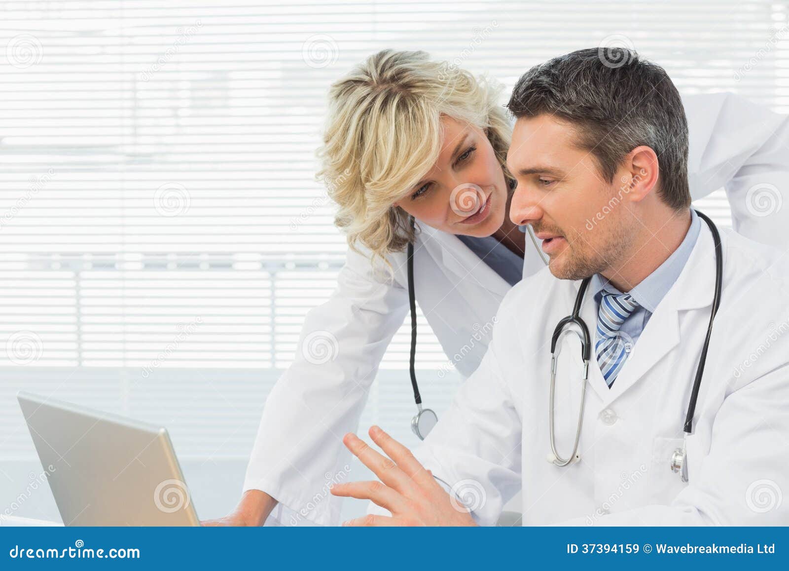 Two Concentrated Doctors Using Laptop Together Stock Image - Image of ...