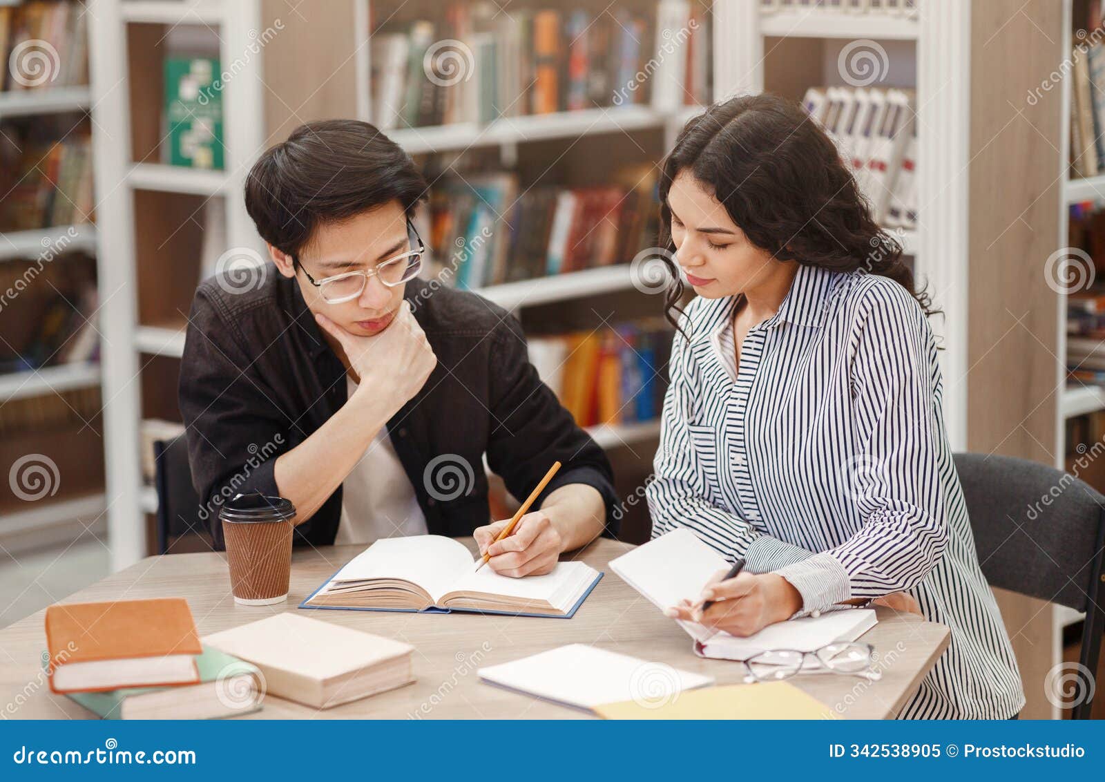 Two Concentrated Multiracial Students Learning at Library Stock Image ...