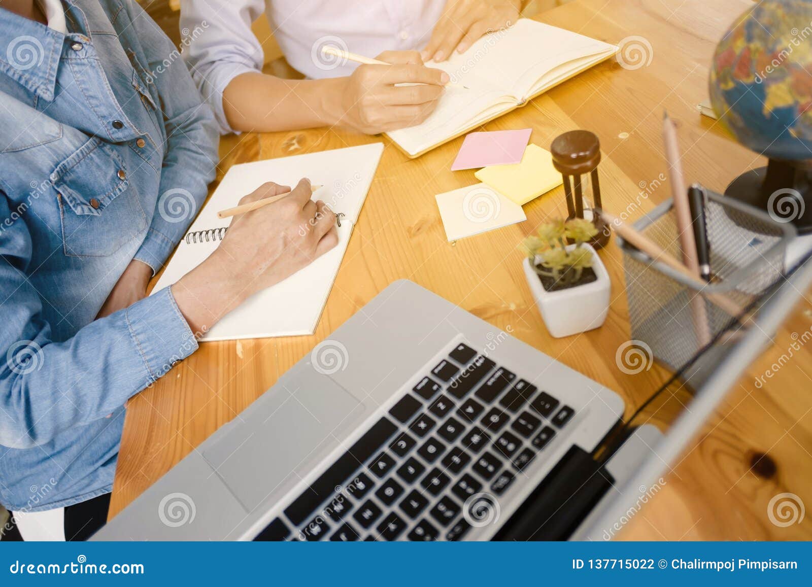 Two Confident Students Doing Homework Together while Sitting at the ...