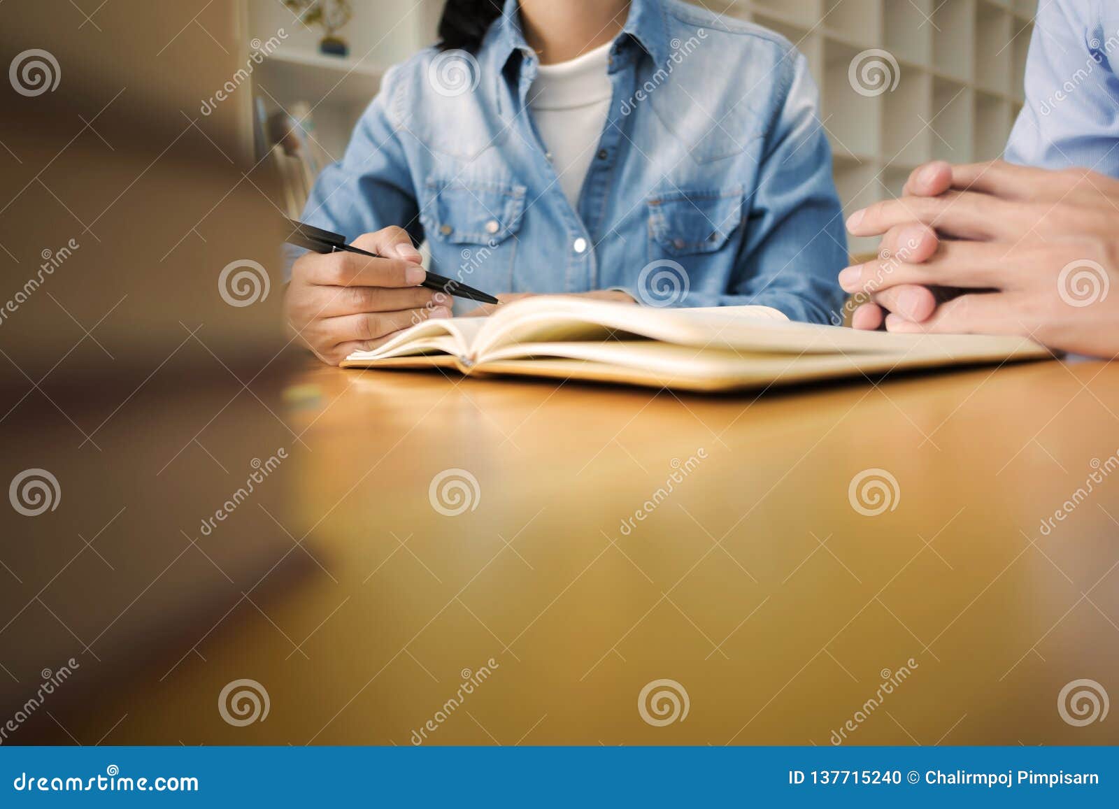 Two Confident Students Reading a Book or Doing Homework Together while ...