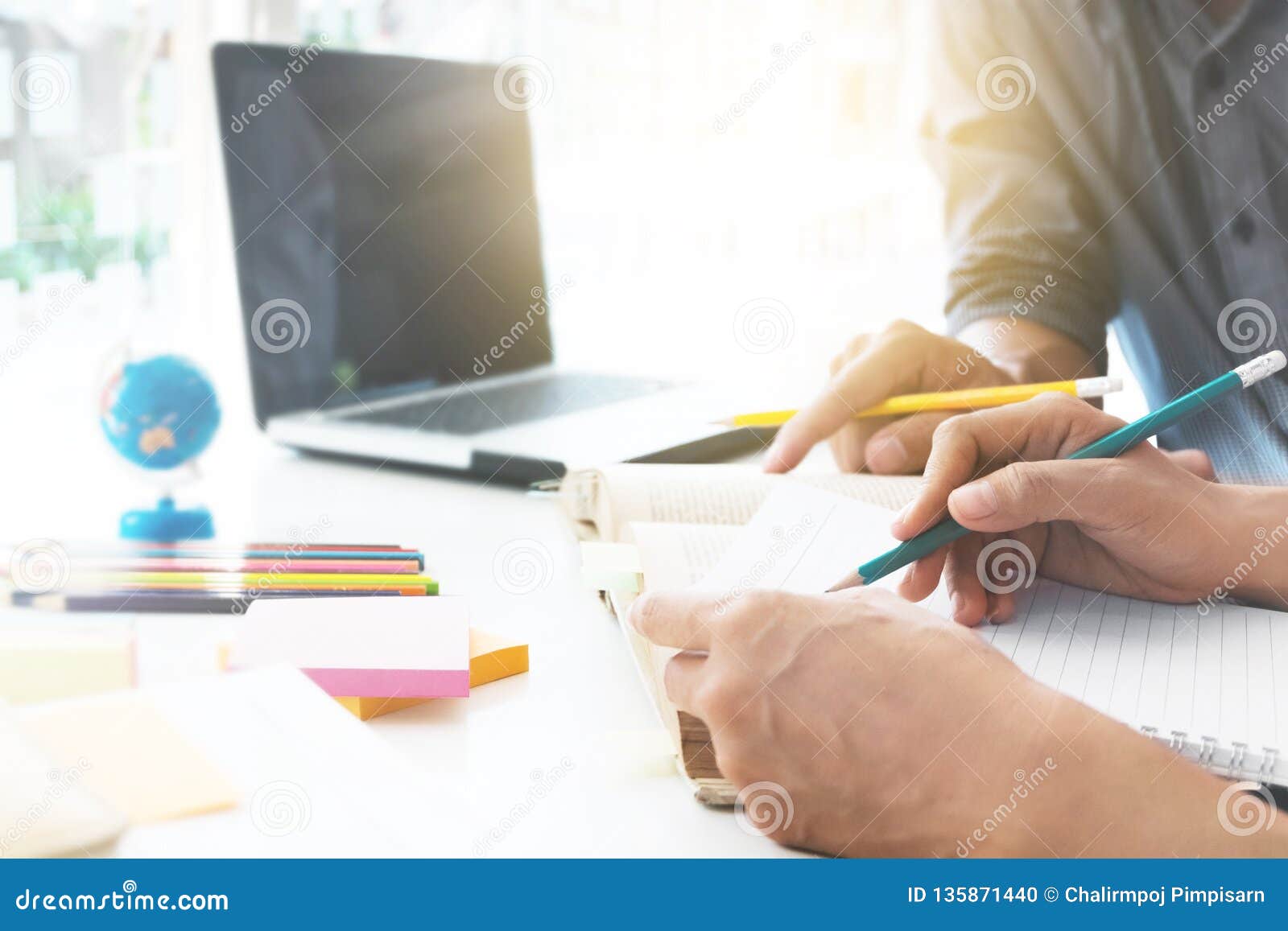 Two Confident Students Doing Homework Together While Sitting At The ...