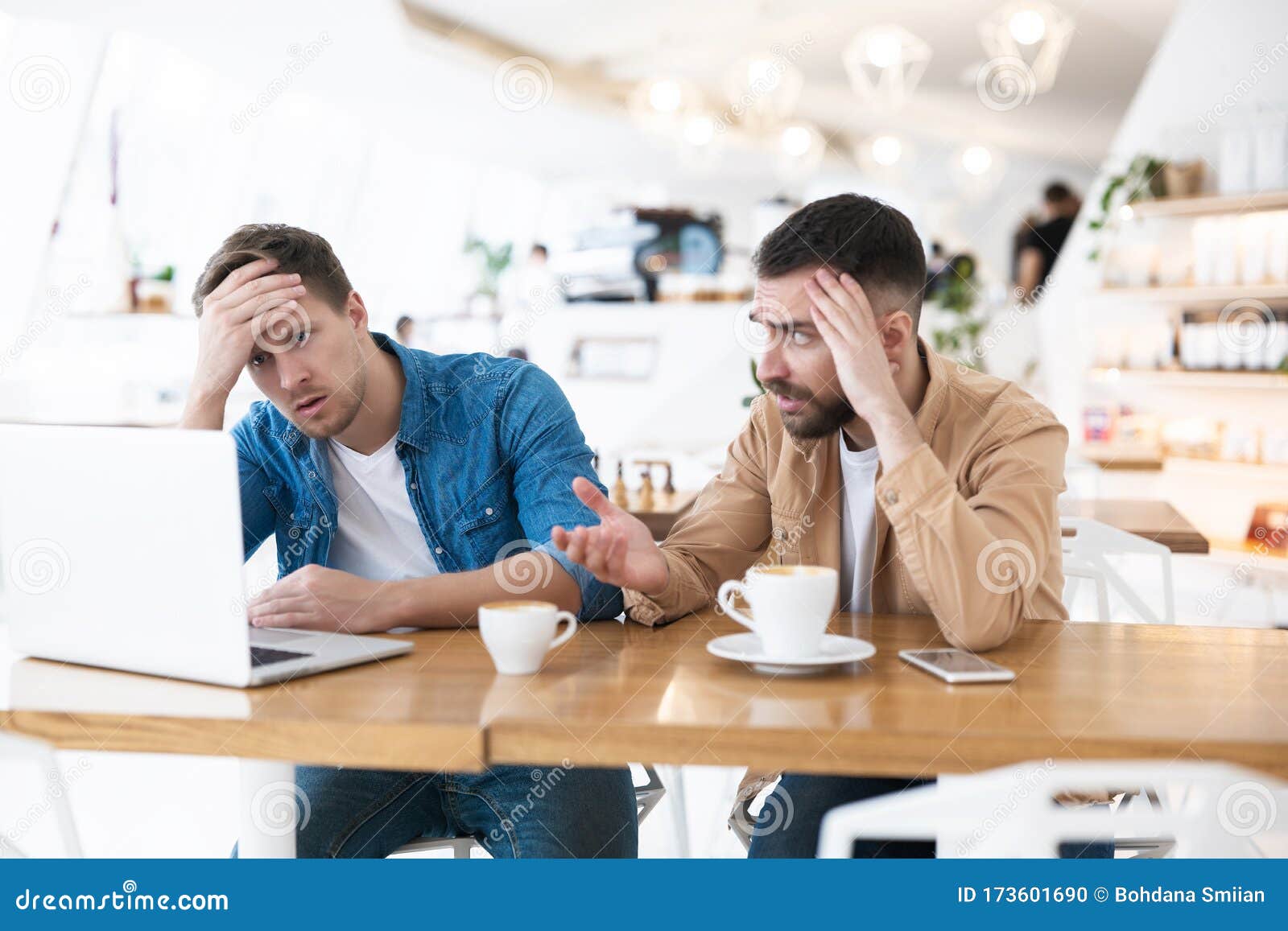 Two Confused Colleagues Men Solving Work Issues during Lunch Break at ...