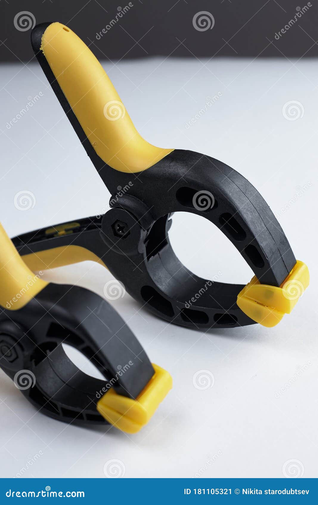 Two Construction Clips Of Different Sizes Of Black And Yellow Close-up ...