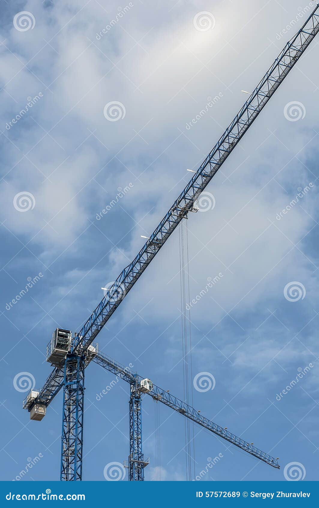 Two Construction Cranes Against the Sky Stock Image - Image of lowering ...