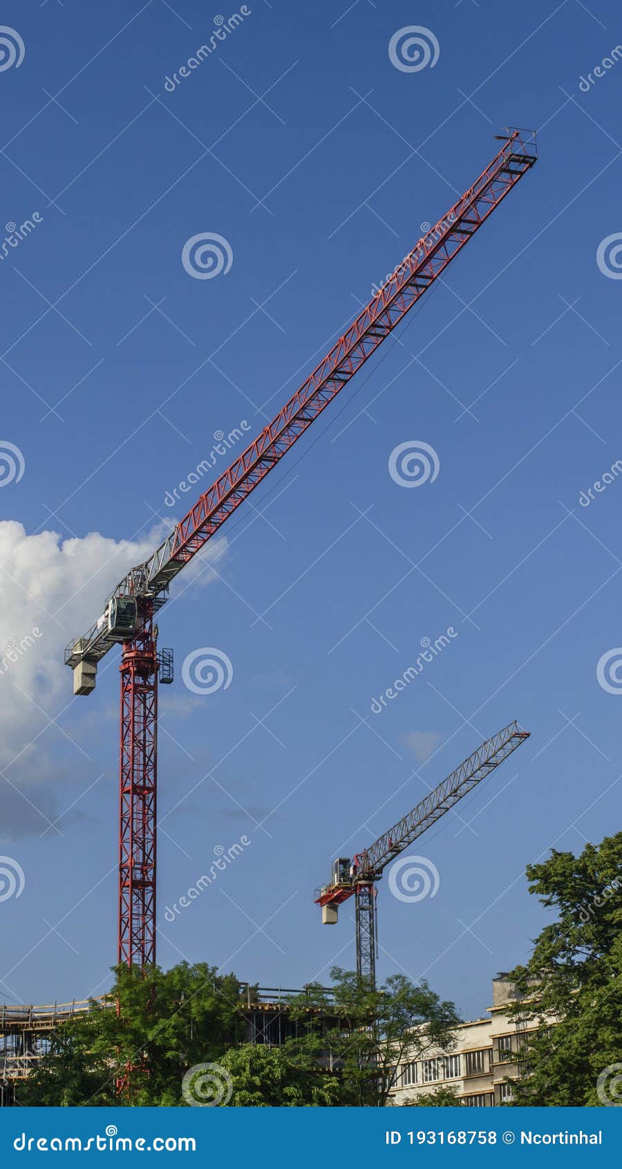 Two Construction Cranes in a Construction Site Stock Photo - Image of ...