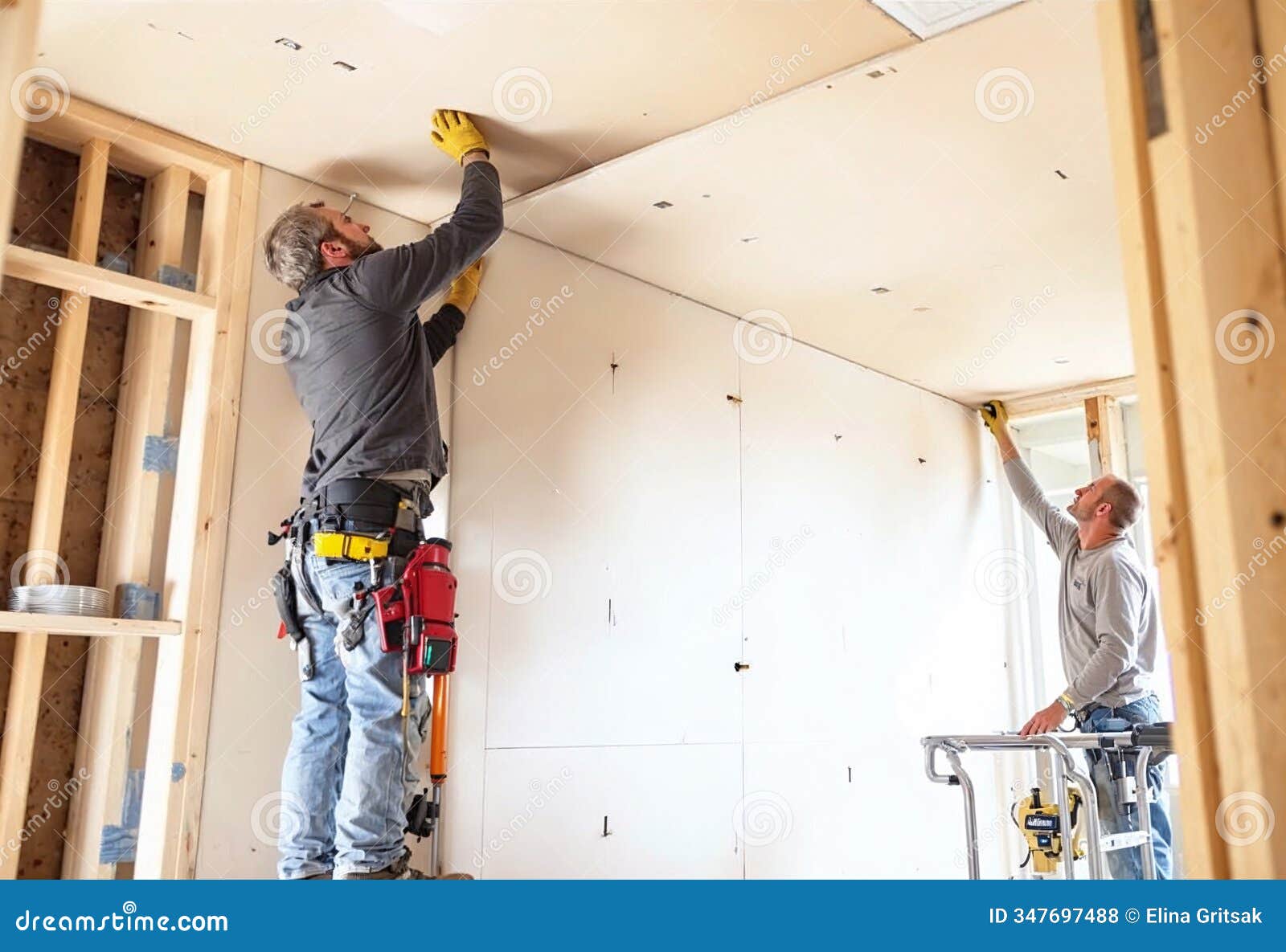 Workers Installing Drywall in a New Home Construction Site during a ...
