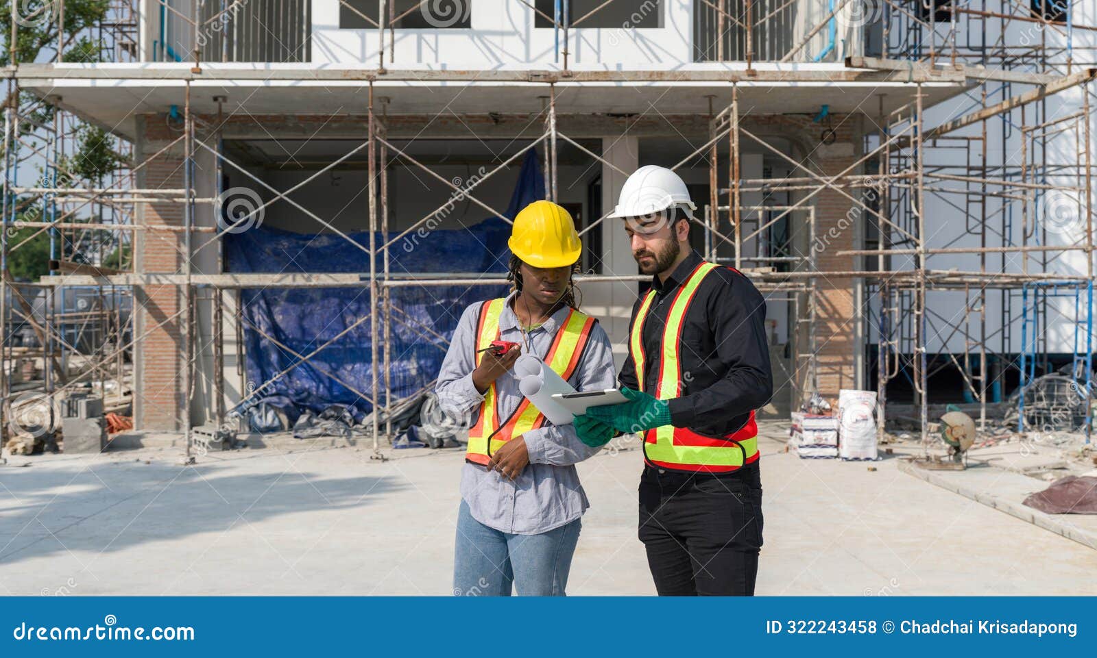 Two Construction Workers Checking Work Schedule on Tablet Computer ...