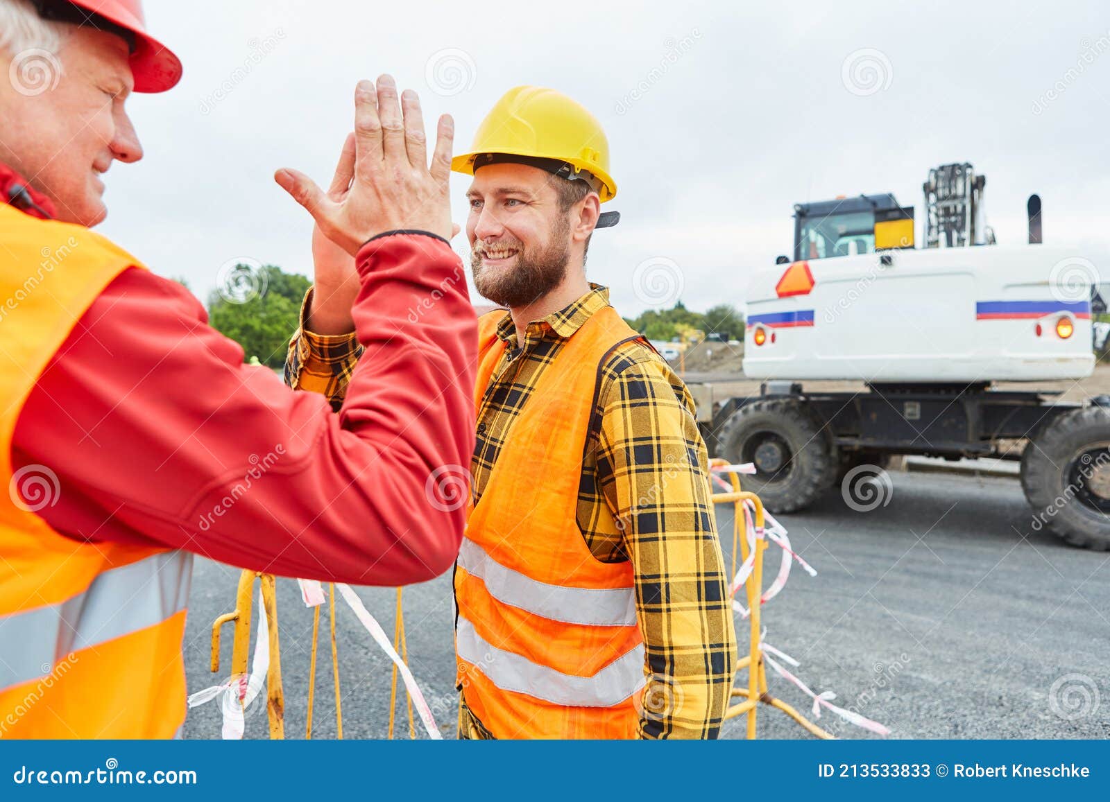 Construction Workers Give Each Other a High Five on the Construction ...