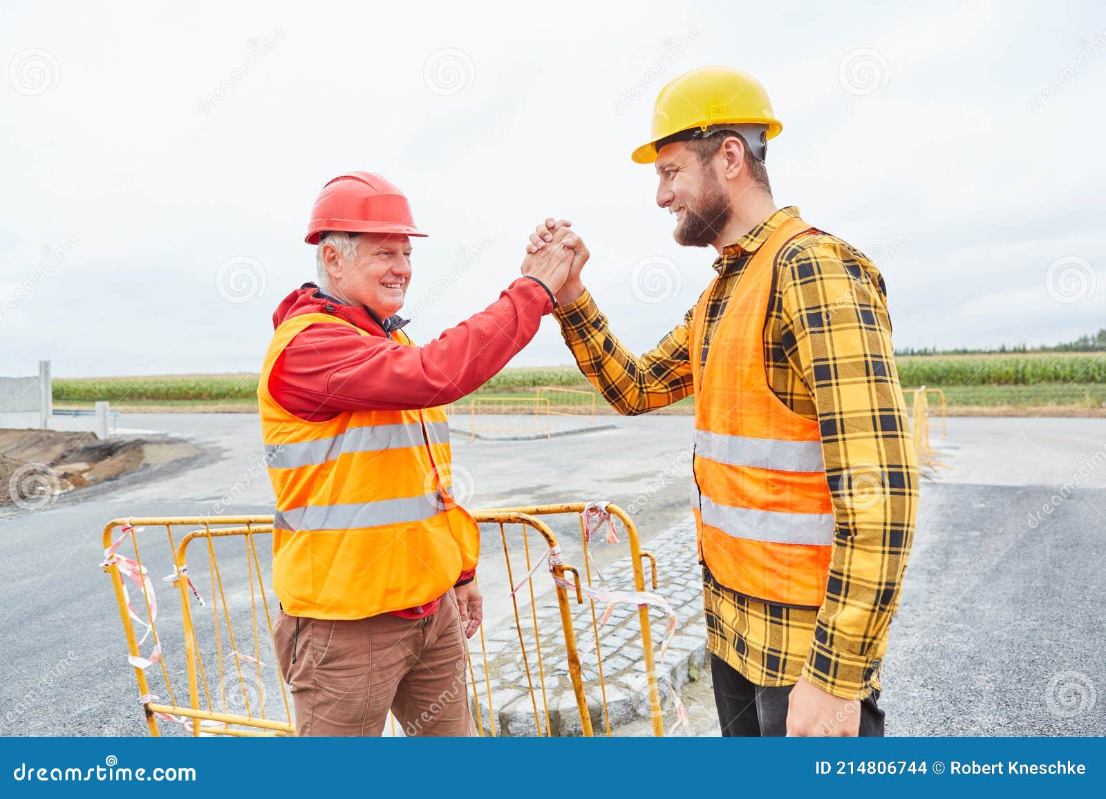 Two Construction Workers Greet Each Other with a Handshake Stock Photo ...