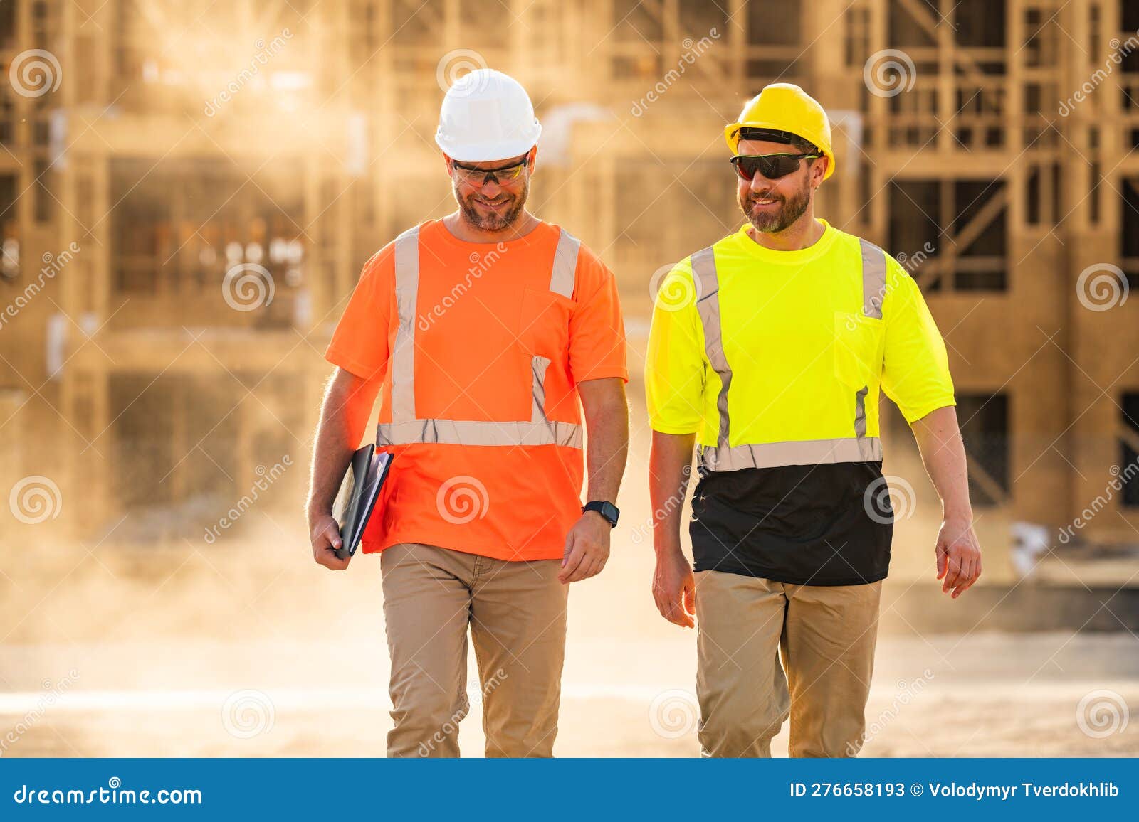 Two Construction Workers with Hardhat Helmet on Construction Site ...