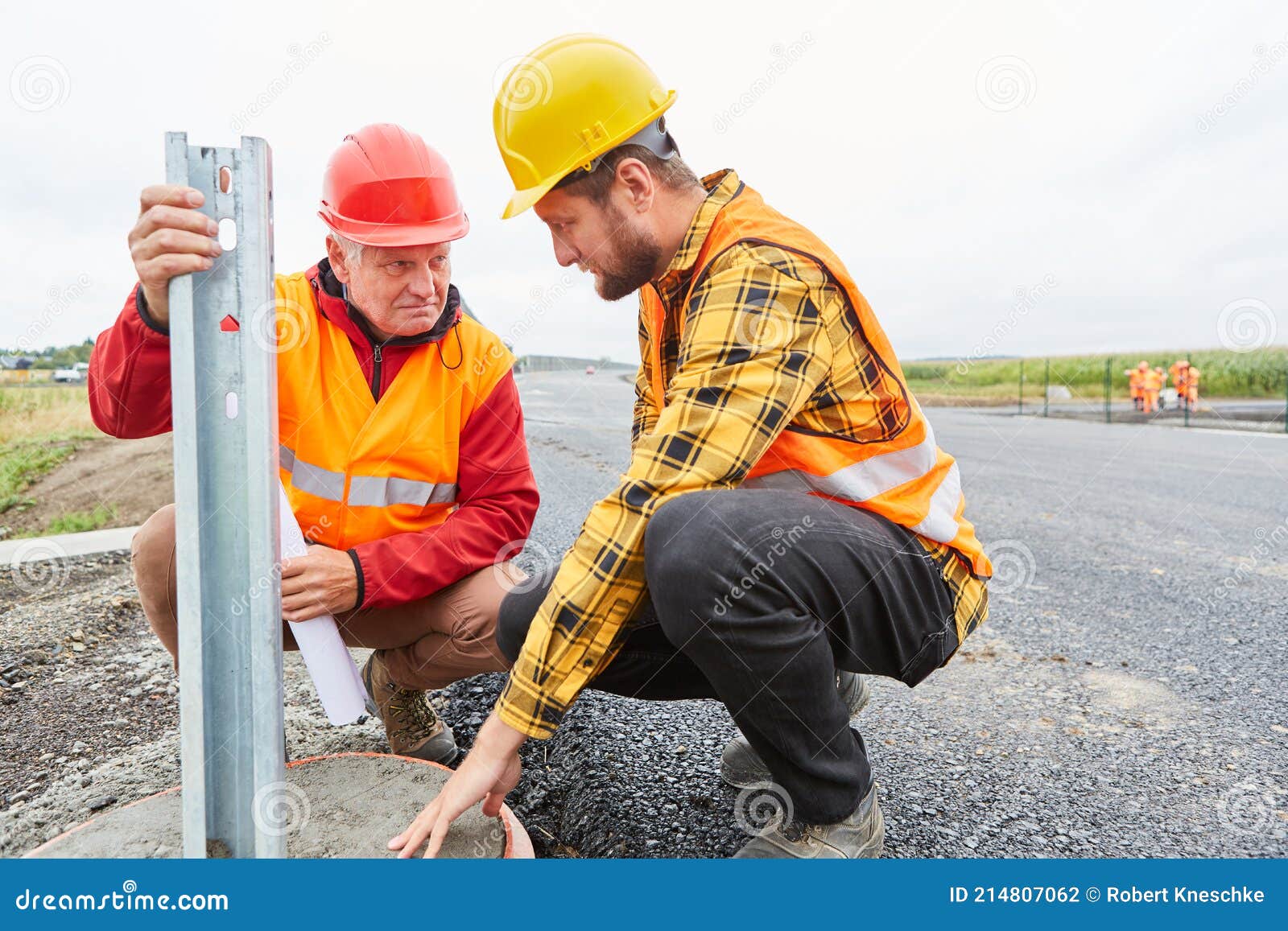 Two Construction Workers during an Inspection on the Construction Site ...