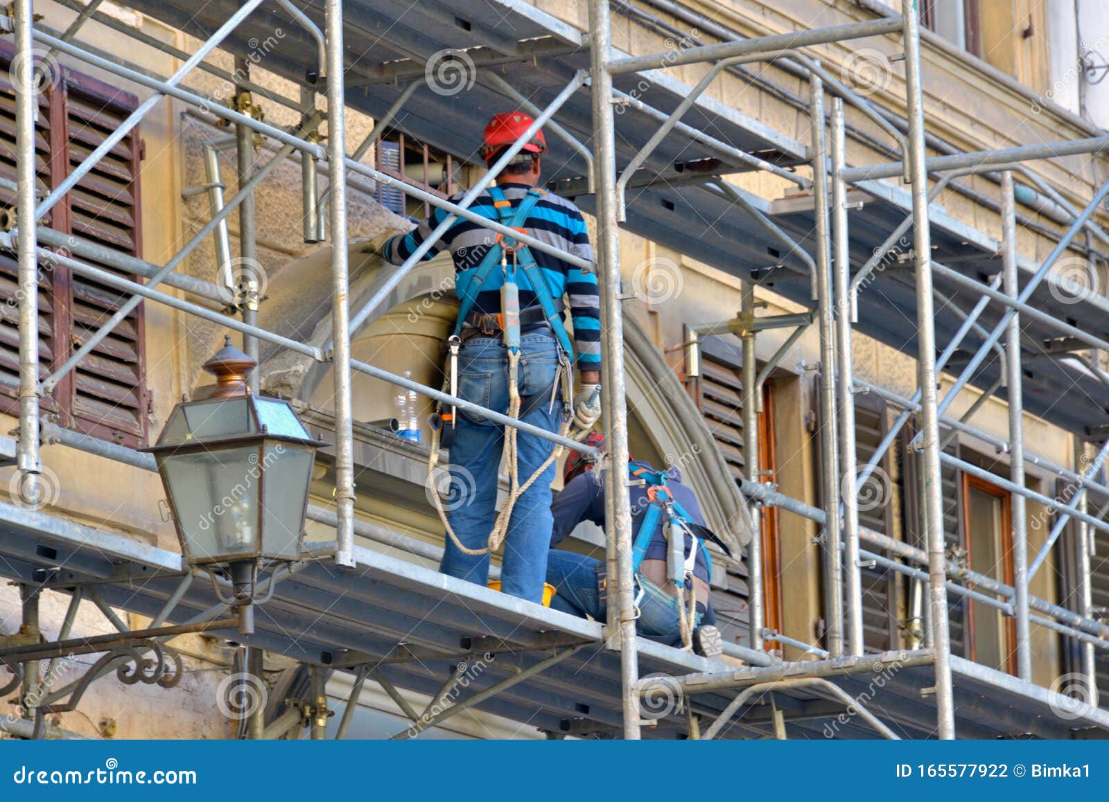 Two Construction Workers are Reconstructing the Facade Editorial ...