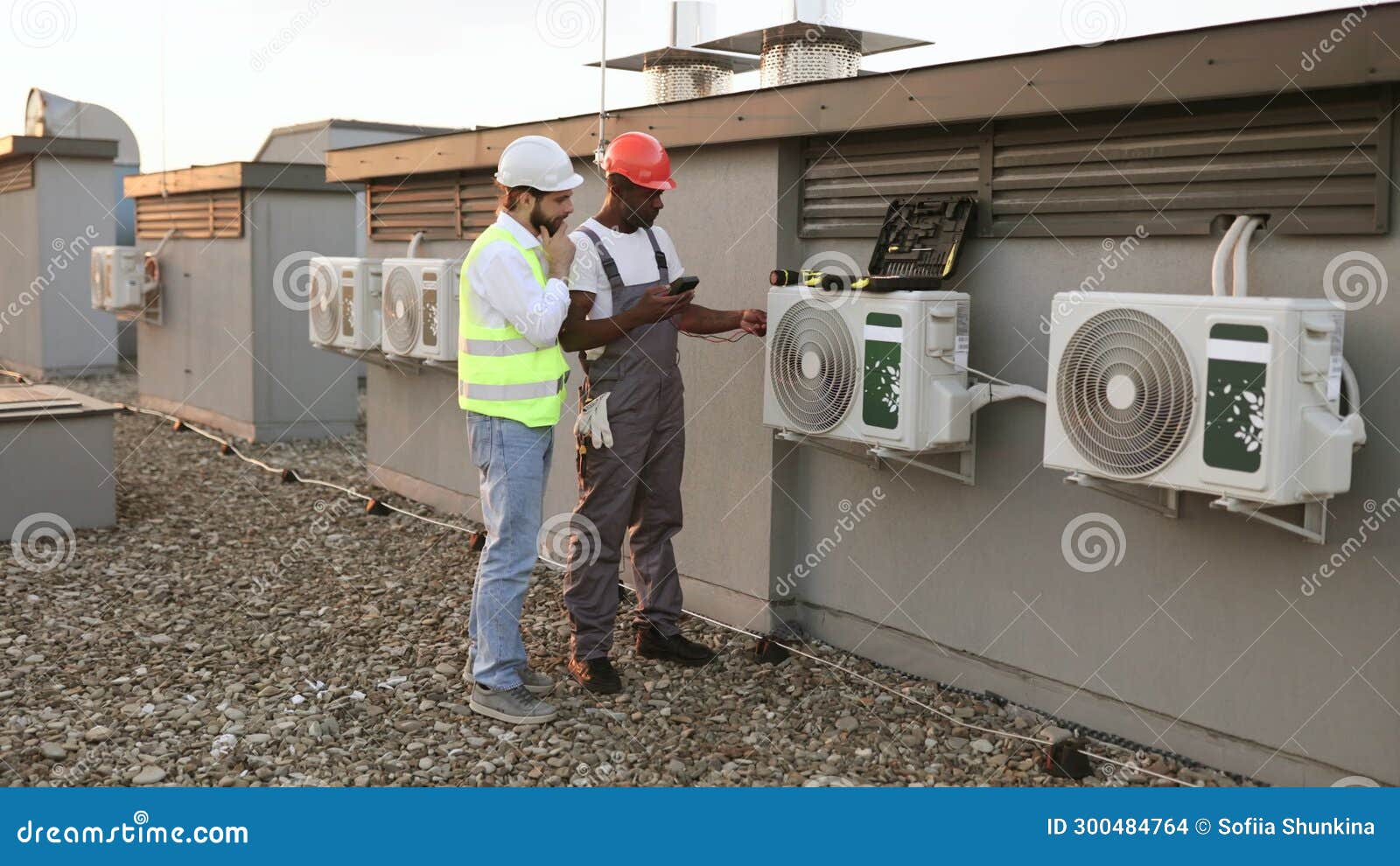 Two Construction Workers on Roof Inspecting Cooling System Stock ...