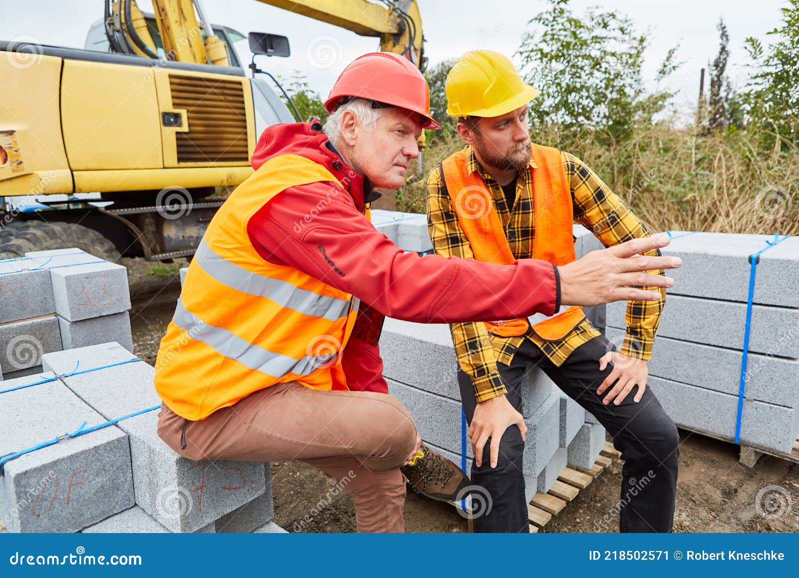 Two Construction Workers on the Construction Site with Building ...