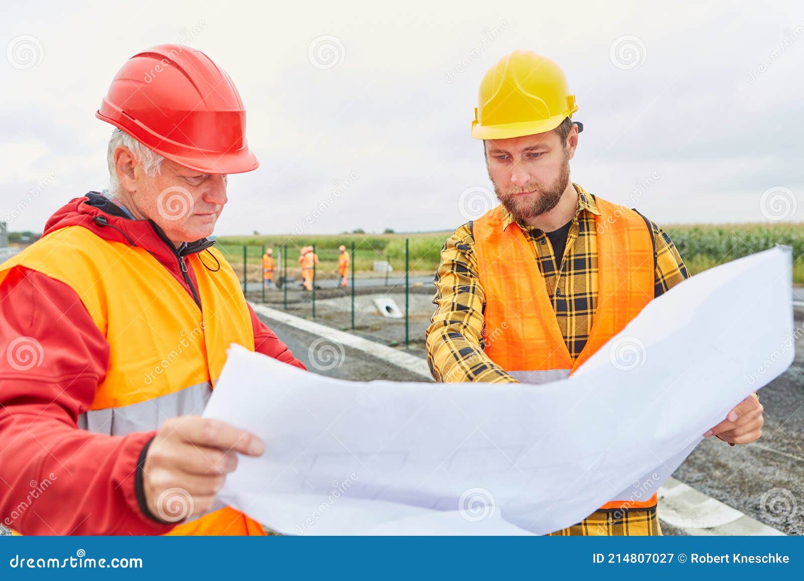 Two Construction Workers with Site Plan for House Building Project ...