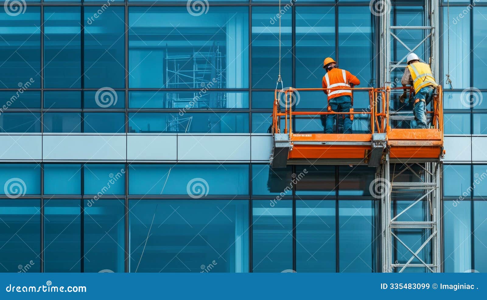 Two Construction Workers in a Suspended Platform Cleaning a Tall Glass ...