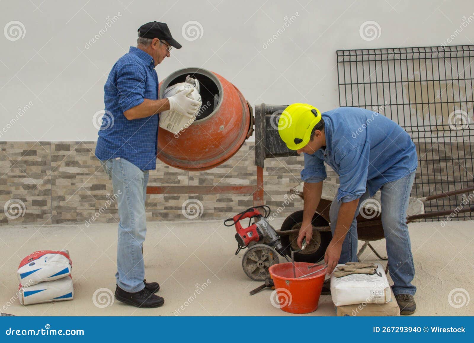 Two Construction Workers at Work on a Construction Site while Kneading ...