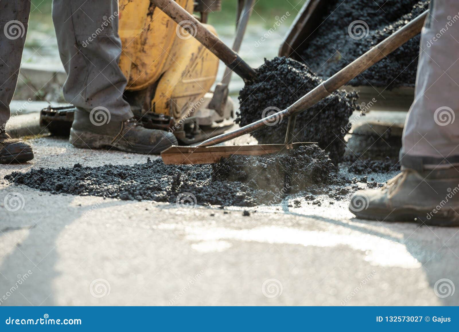 Two Construction Workers Patching Bump in the Road Stock Image - Image ...