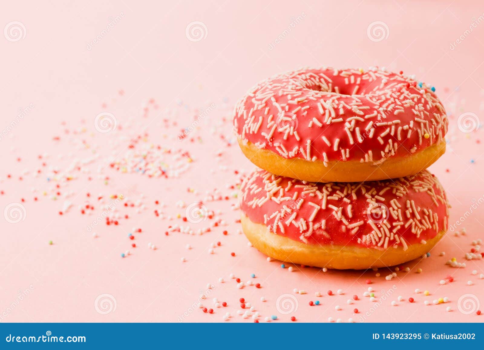 Two Coral Donuts Standing in a Line. Donuts Decorated with Icing Stock ...
