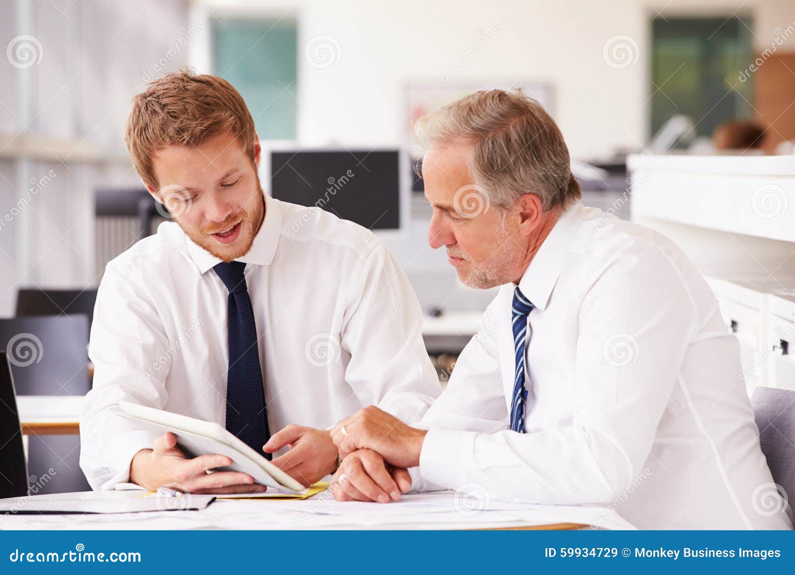 Two Corporate Business Colleagues Working Together in Office Stock ...