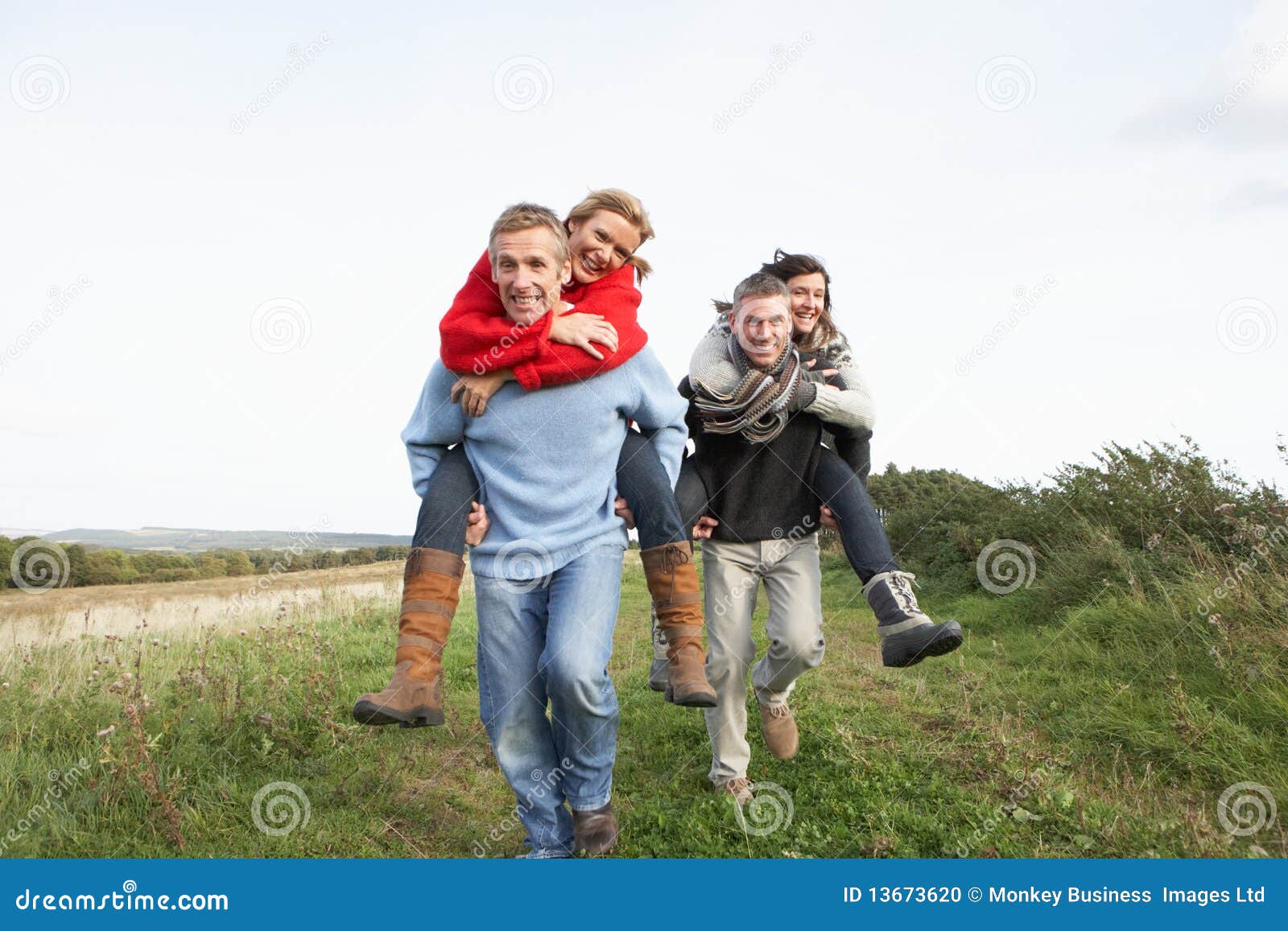 Two Couples Having Piggyback Ride Stock Photo - Image of landscape ...