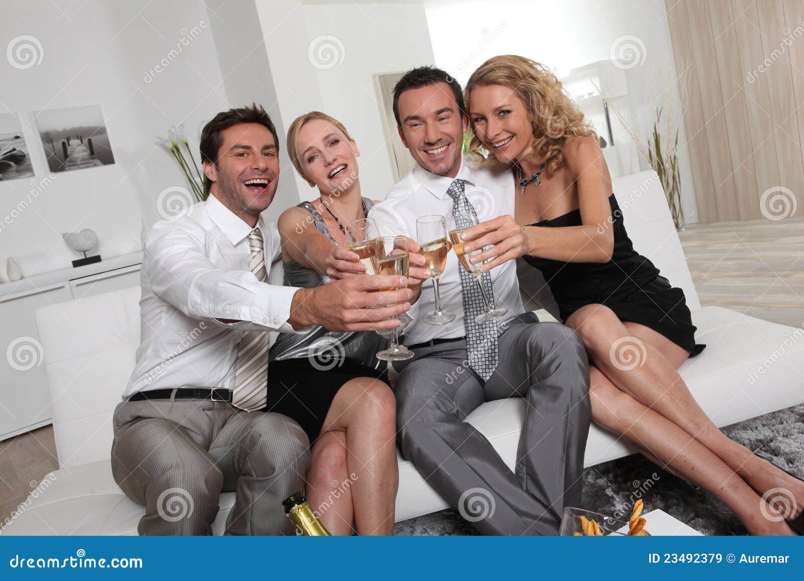 Two couples partying stock image. Image of pretty, toasting - 23492379