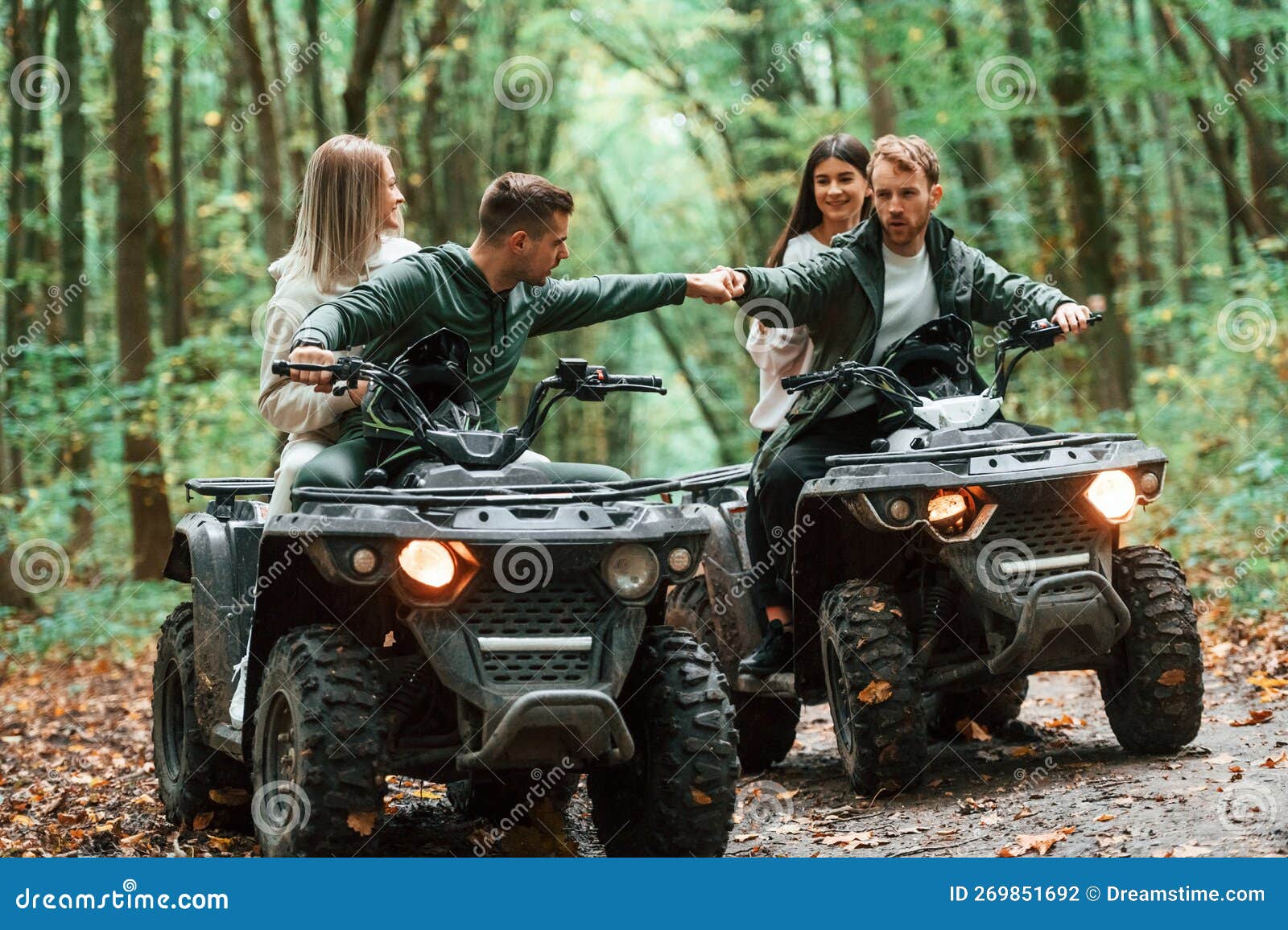 Two Couples on a Quad Bike in the Forest during the Day Stock Photo ...