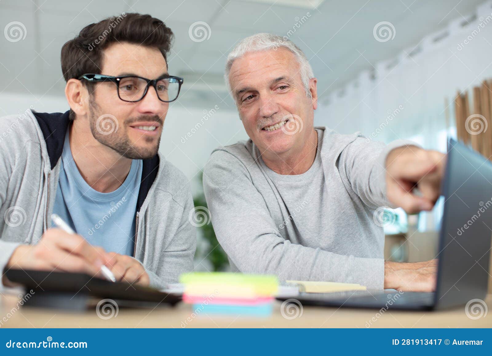 Two Coworkers Discussing Project Over Laptop Stock Image - Image of ...