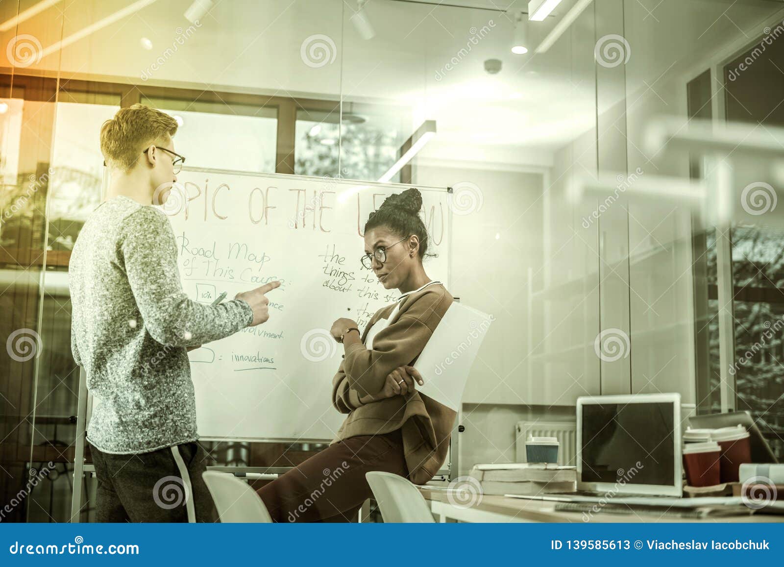 Two Coworkers Discussing Topic of the Day in Their Modern Office Stock ...