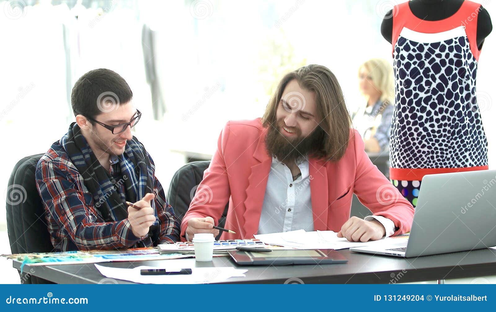 Two Creative Designers Discuss New Ideas Sitting at a Table in a ...