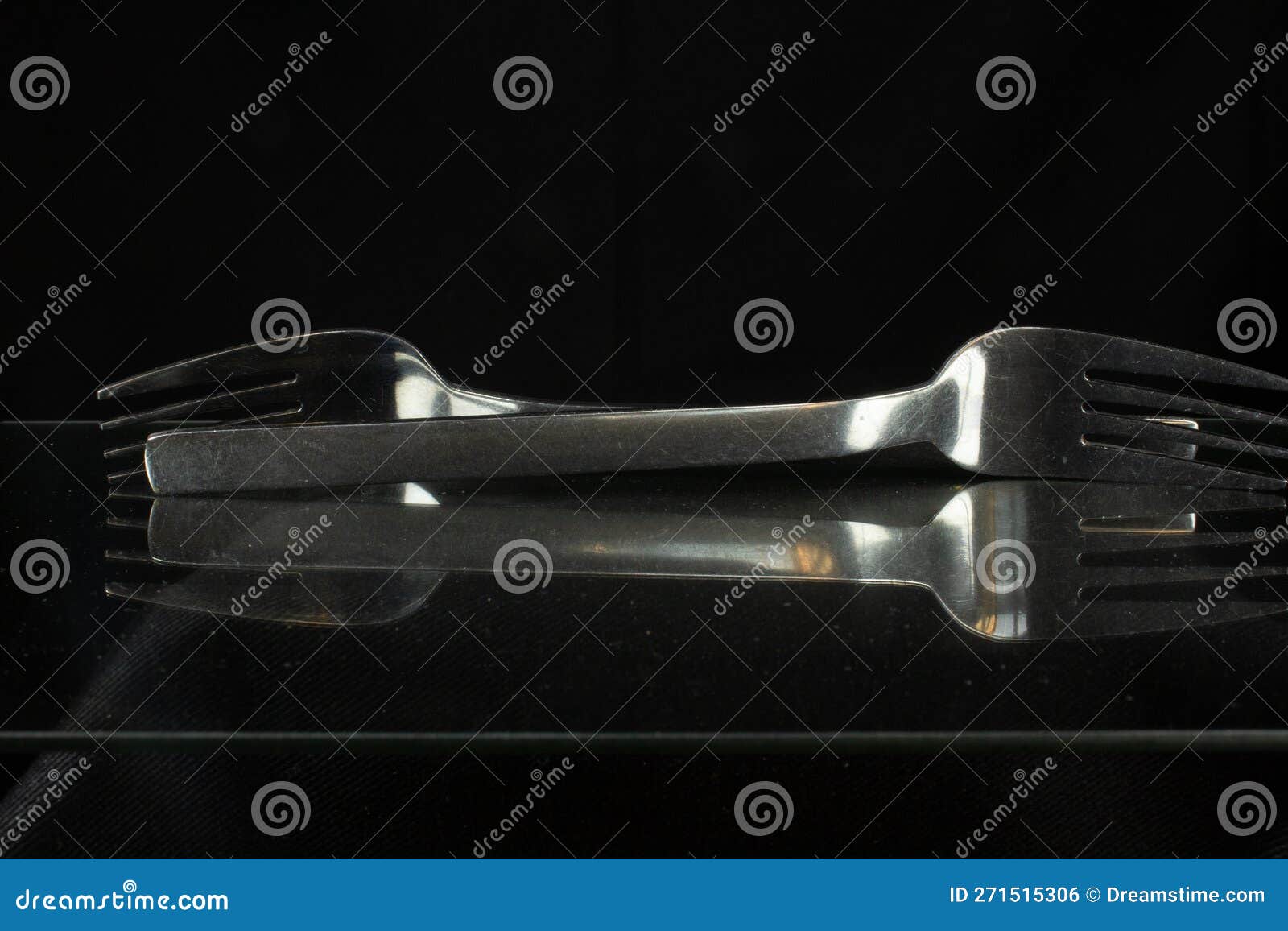 Two Crossing Silver Dinner Forks Stock Photo - Image of guitar, light ...