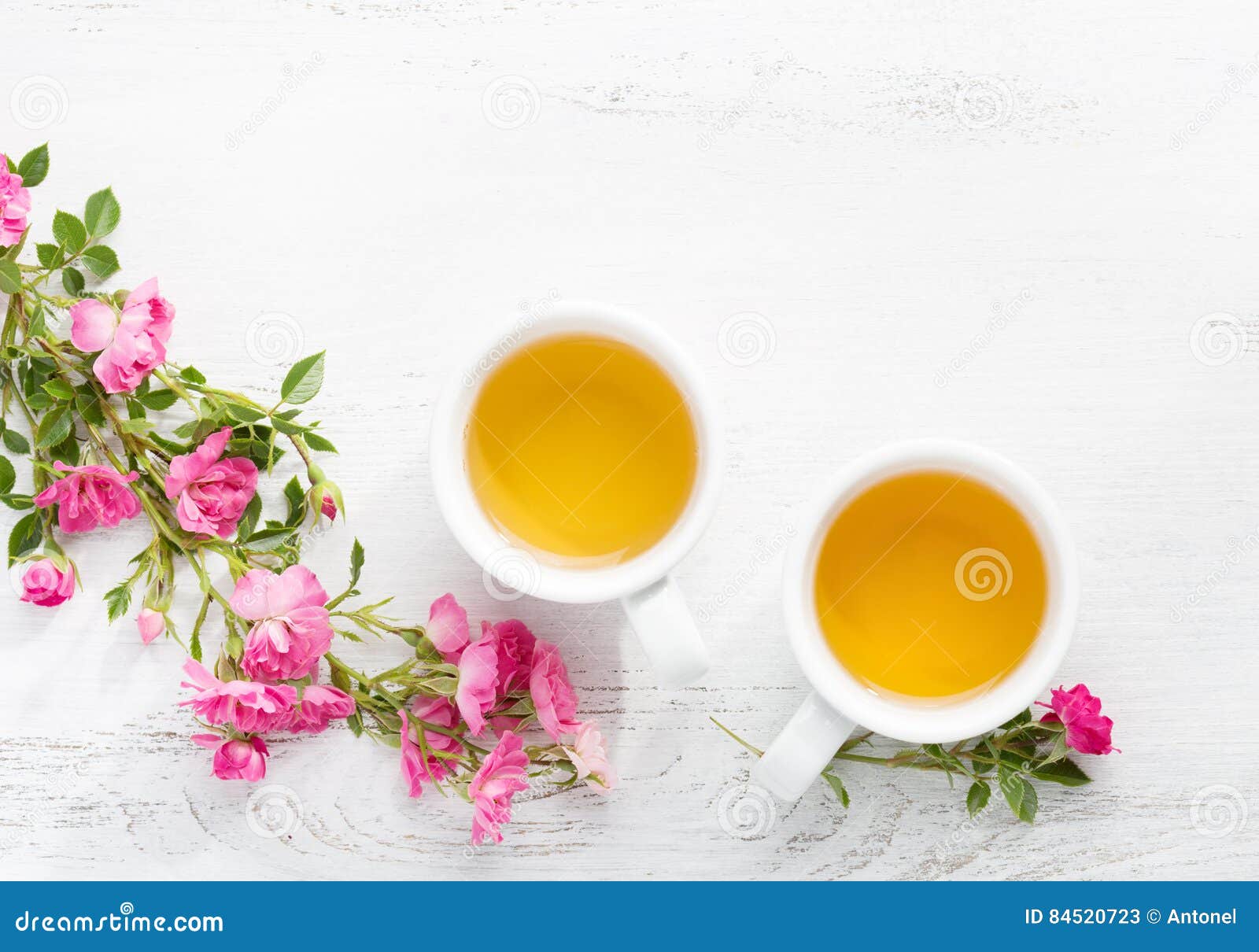 Two Cups of Tea and Branch of Small Pink Roses. Stock Image - Image of ...