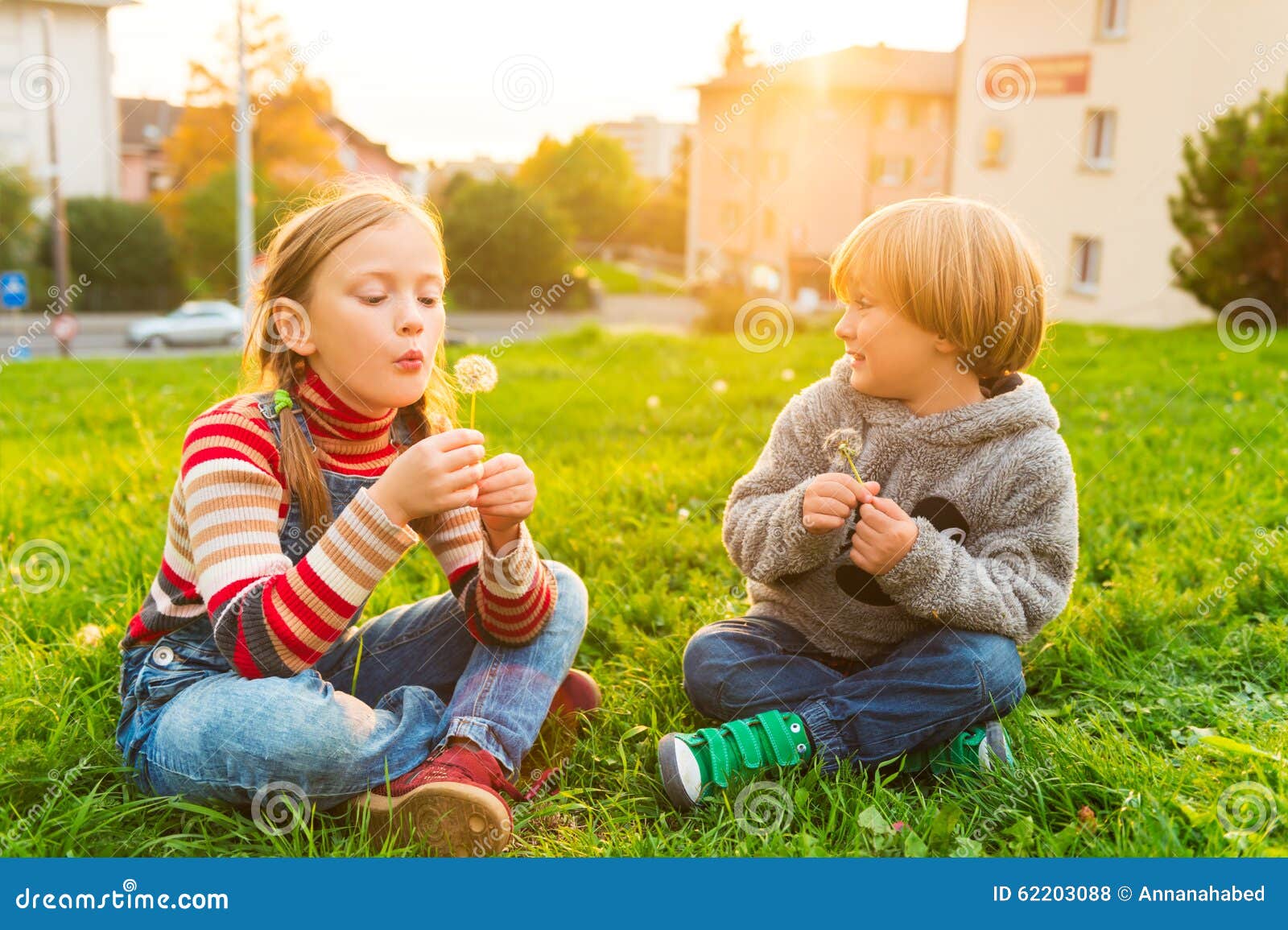 Two cute kids outdoors stock photo. Image of girl, dandelion - 62203088