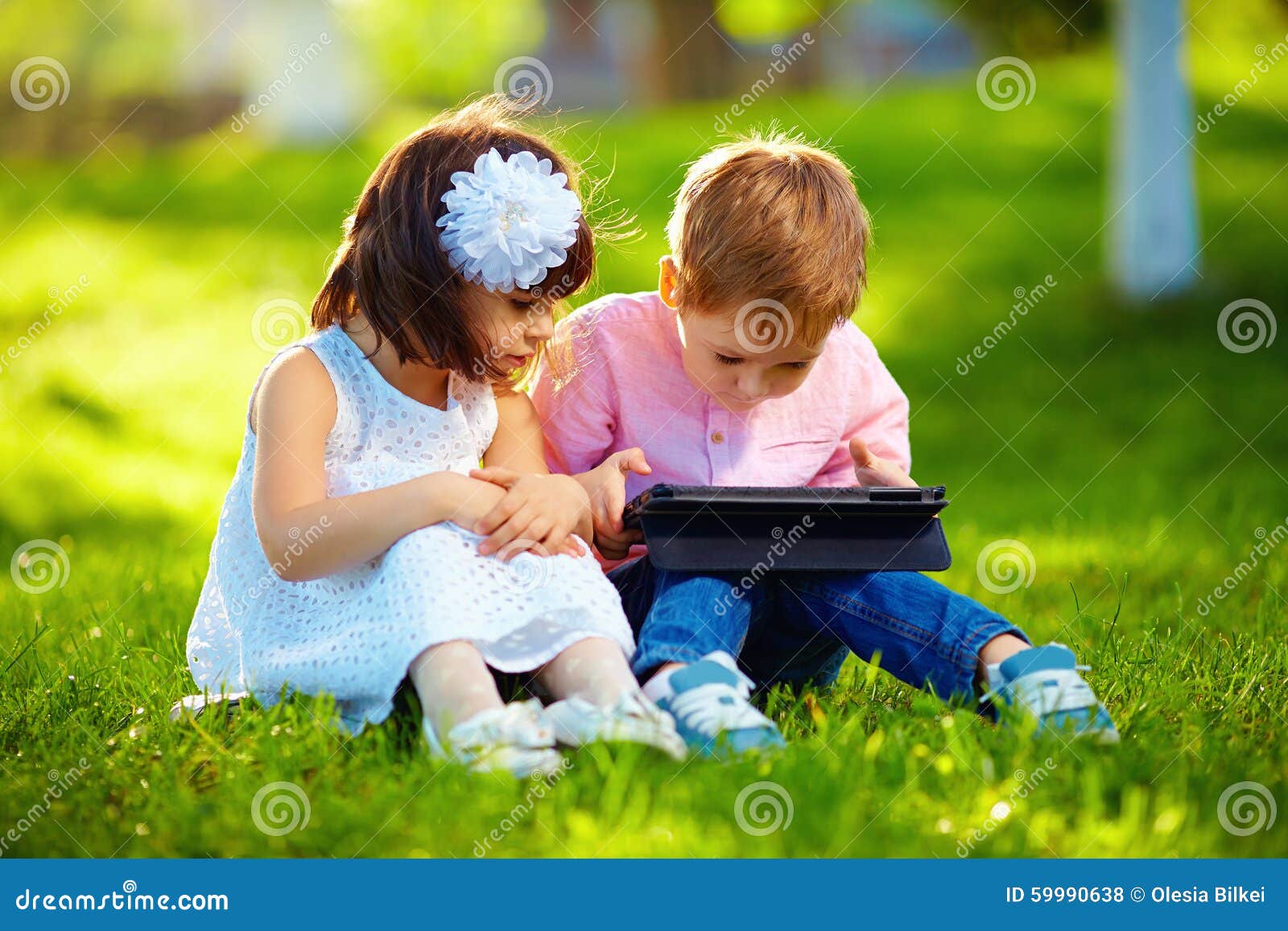 Two Cute Kids Using Digital Tablet in Summer Garden Stock Photo - Image ...