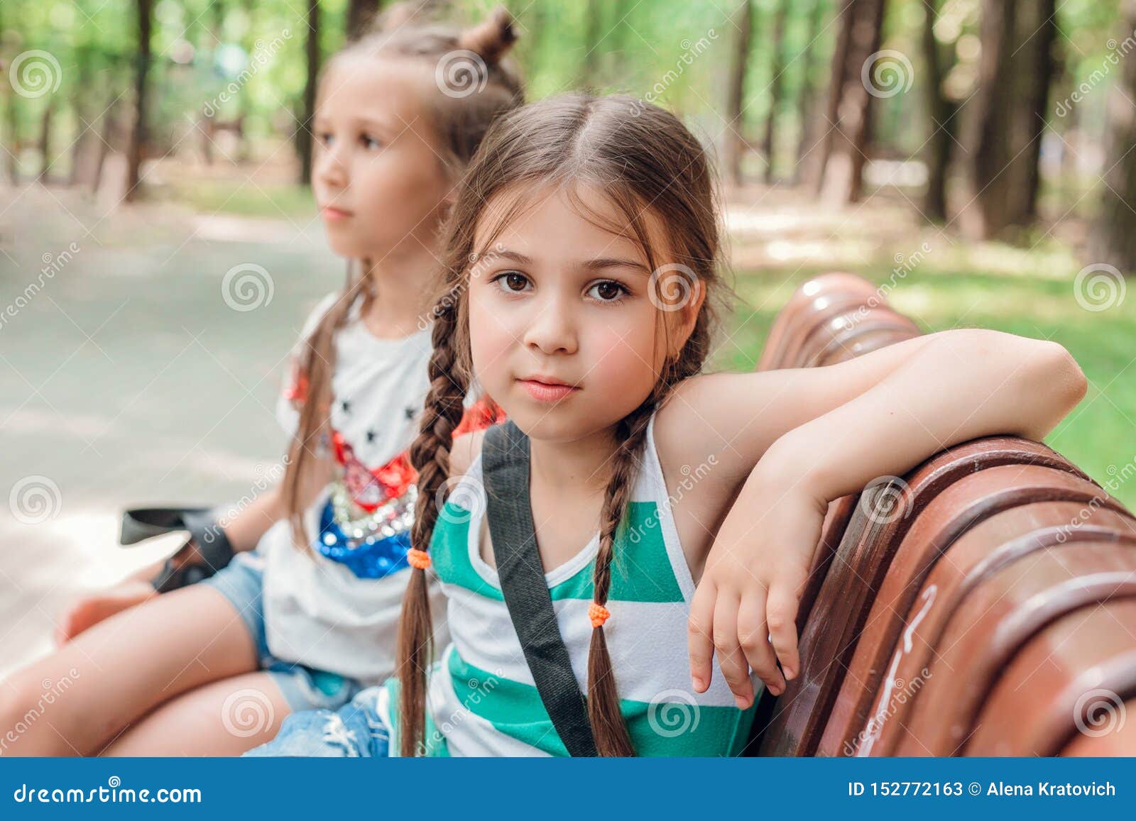 Two Cute Little Girls Sitting on the Wooden Bench in Park Stock Image ... Two Cute Little Girls Sitting on the Wooden Bench in Park Stock Image ...
