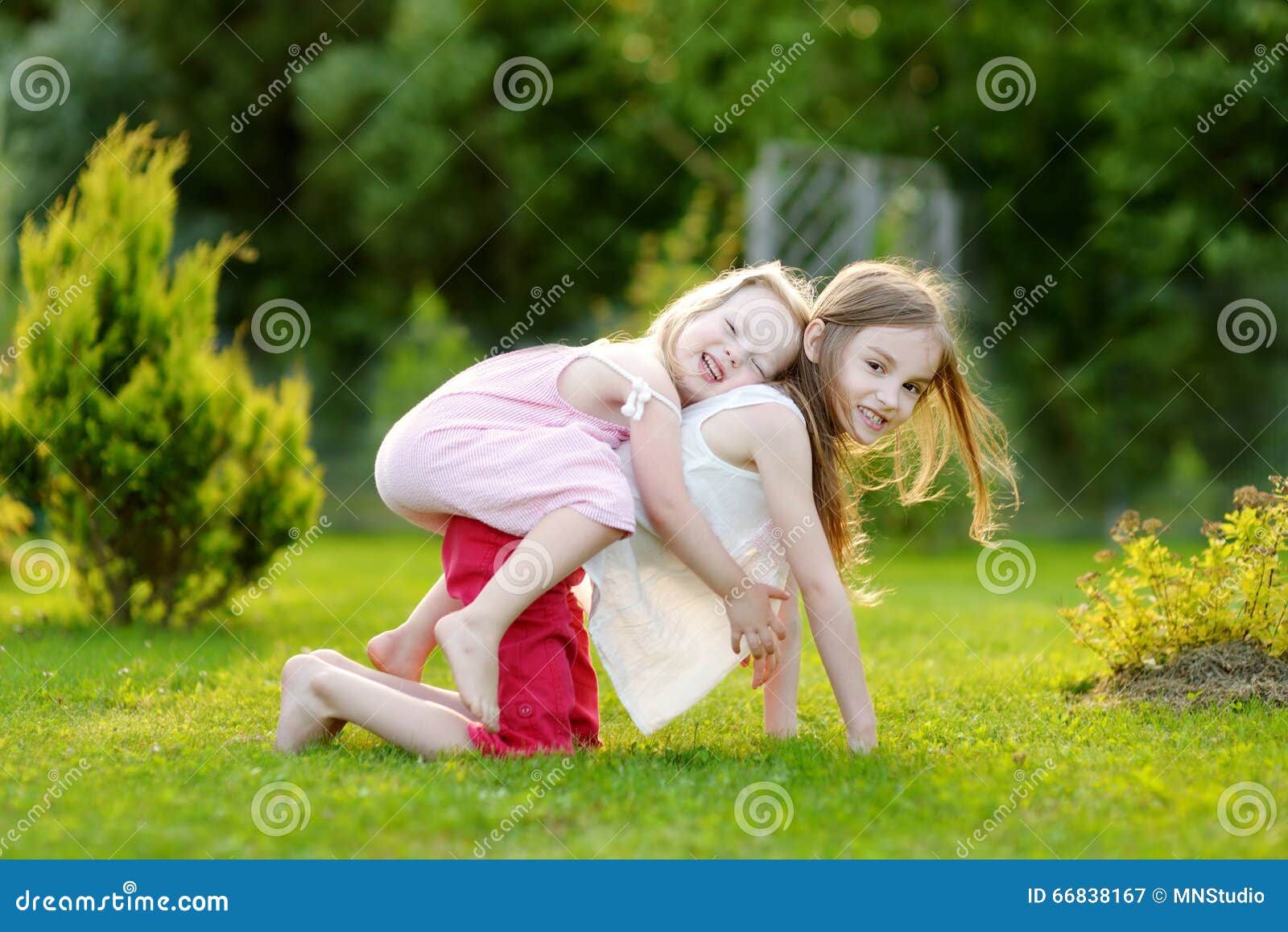 Two Cute Little Sisters Having Fun Together on the Grass Stock Image ...