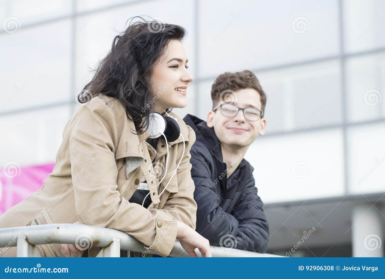 Two Cute Teenagers are Leaning on a Railing and Talking Stock Photo ...