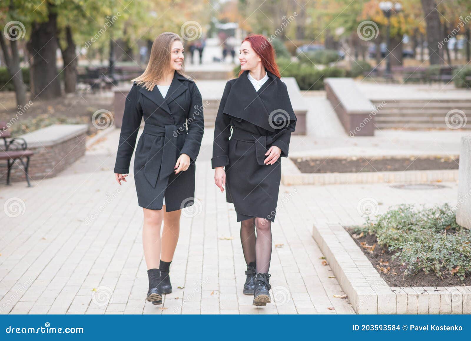 Two Cute Young Girls are Walking and Talking about Important Topics ...