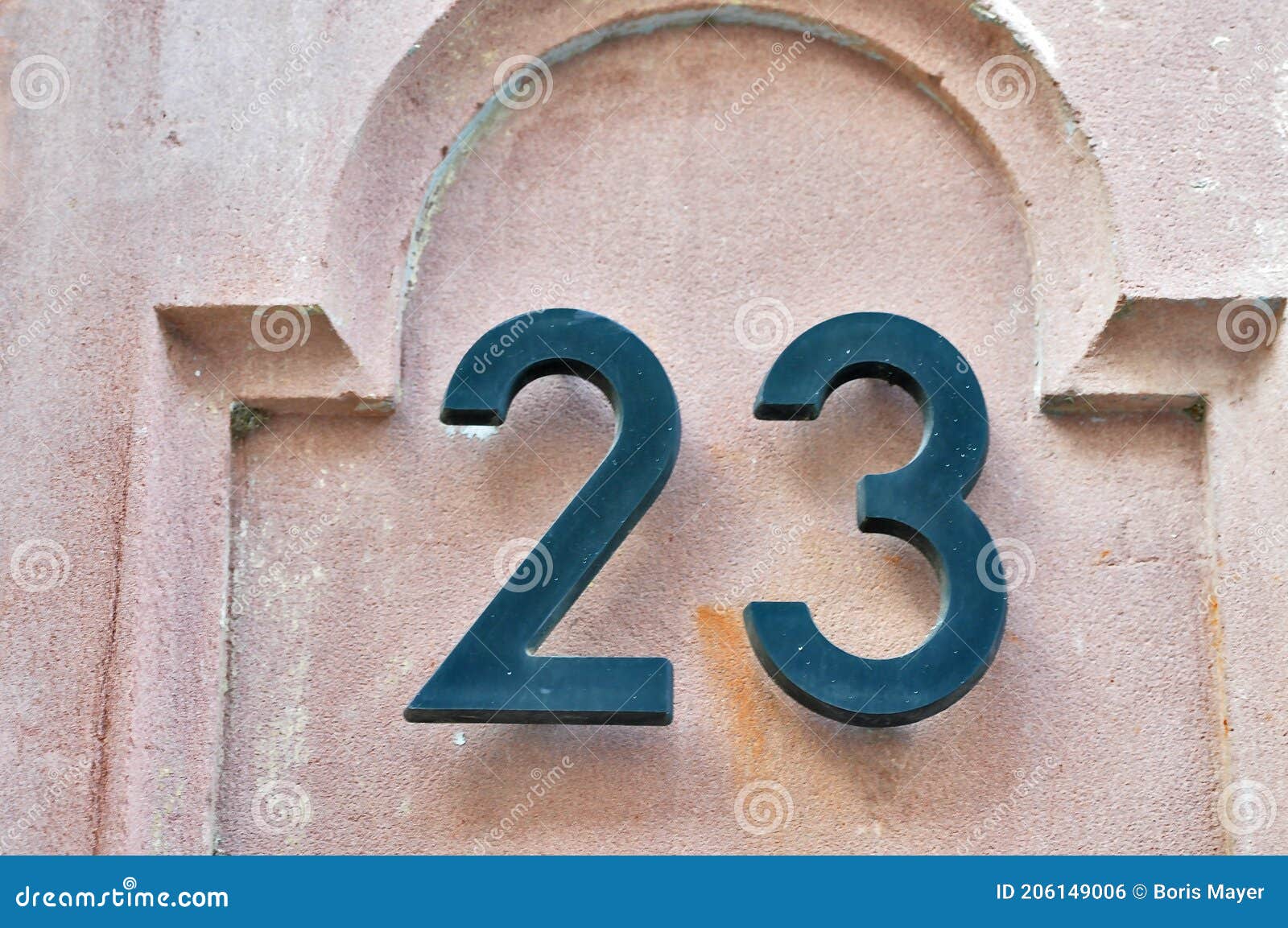 Two Dark Coloured Iron Digits Fixed on a Stone Wall and Showing the ...
